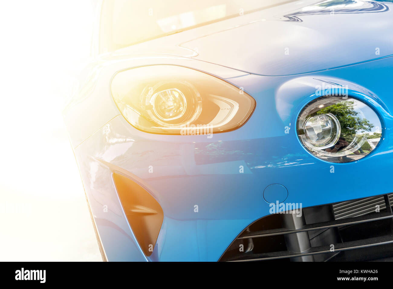 Front of a blue sport car in sunset light background Stock Photo - Alamy