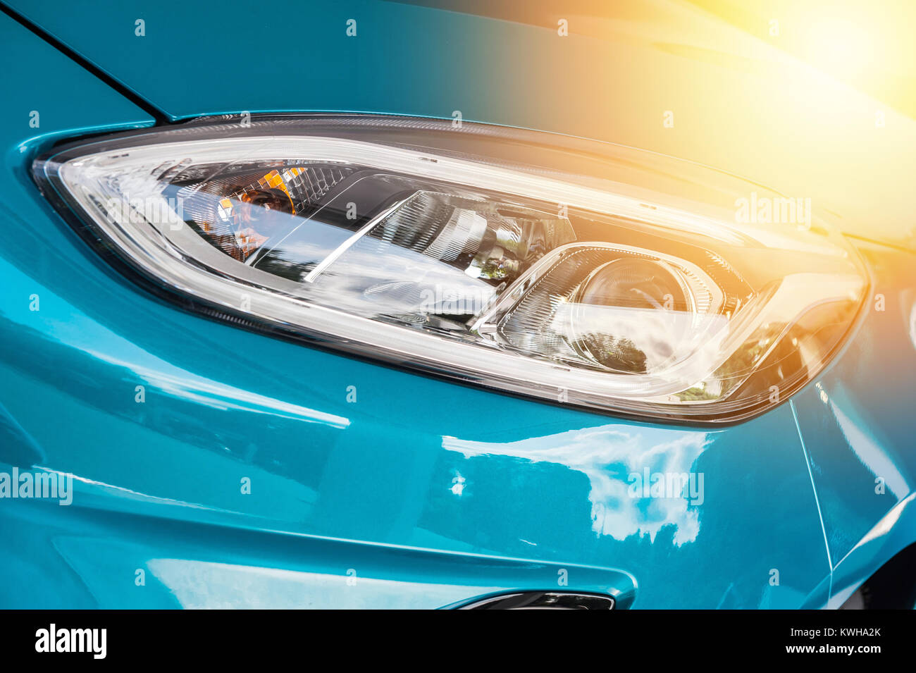 Close up of a blue sport car in sunset background Stock Photo - Alamy