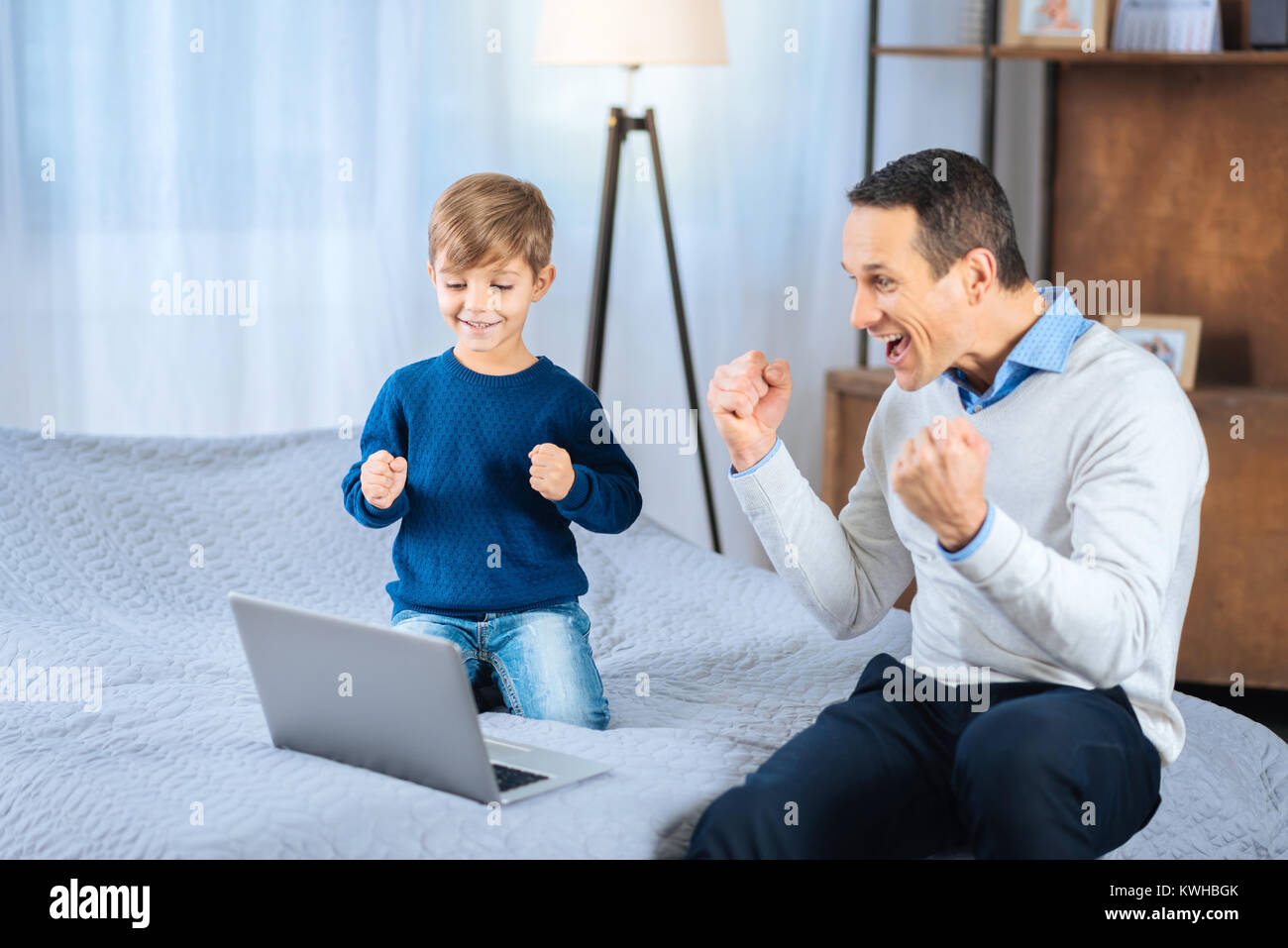 Excited father and son cheering for their football team Stock Photo - Alamy
