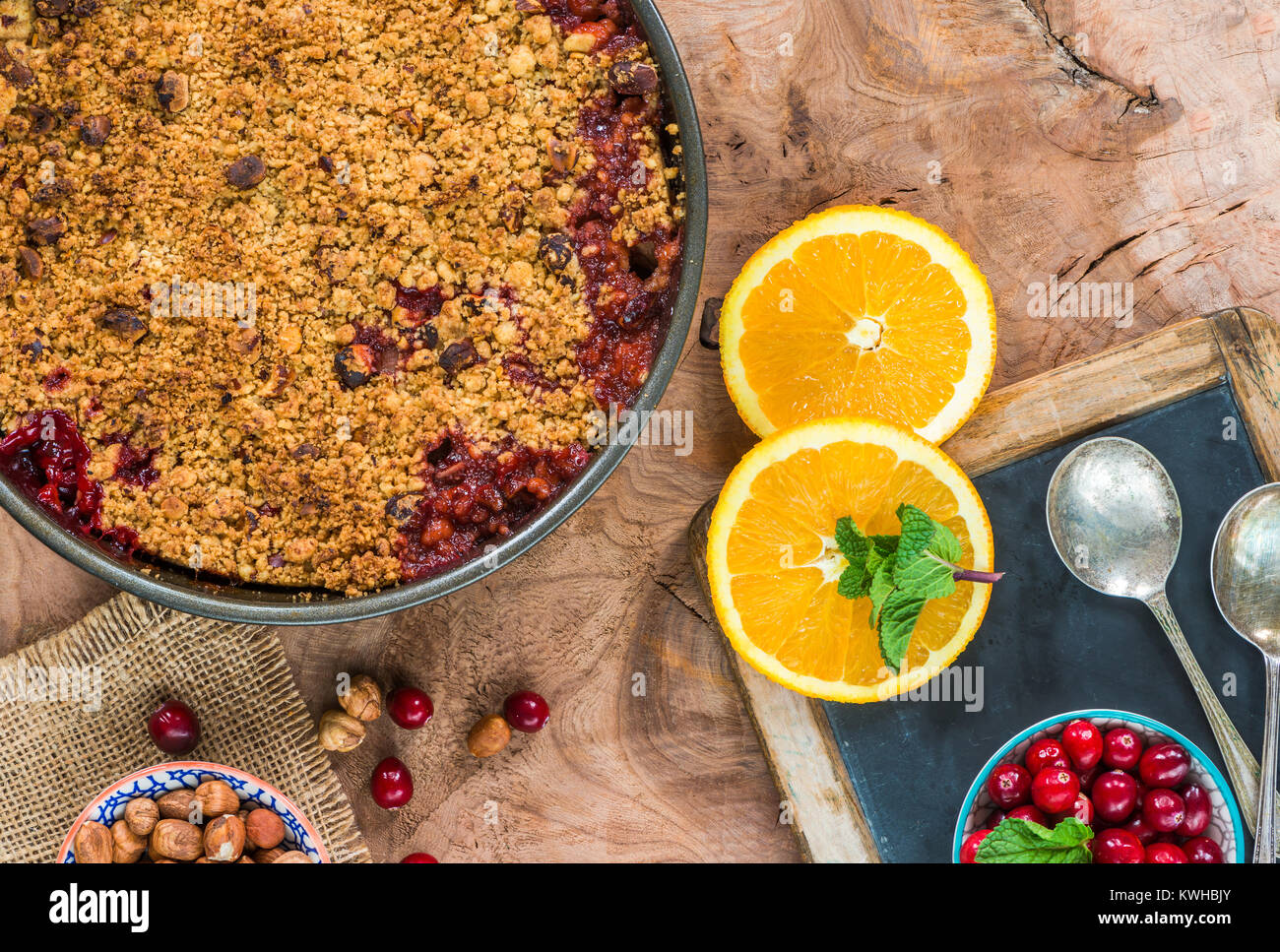 Cranberry, apple and hazelnut crumble - top view Stock Photo - Alamy