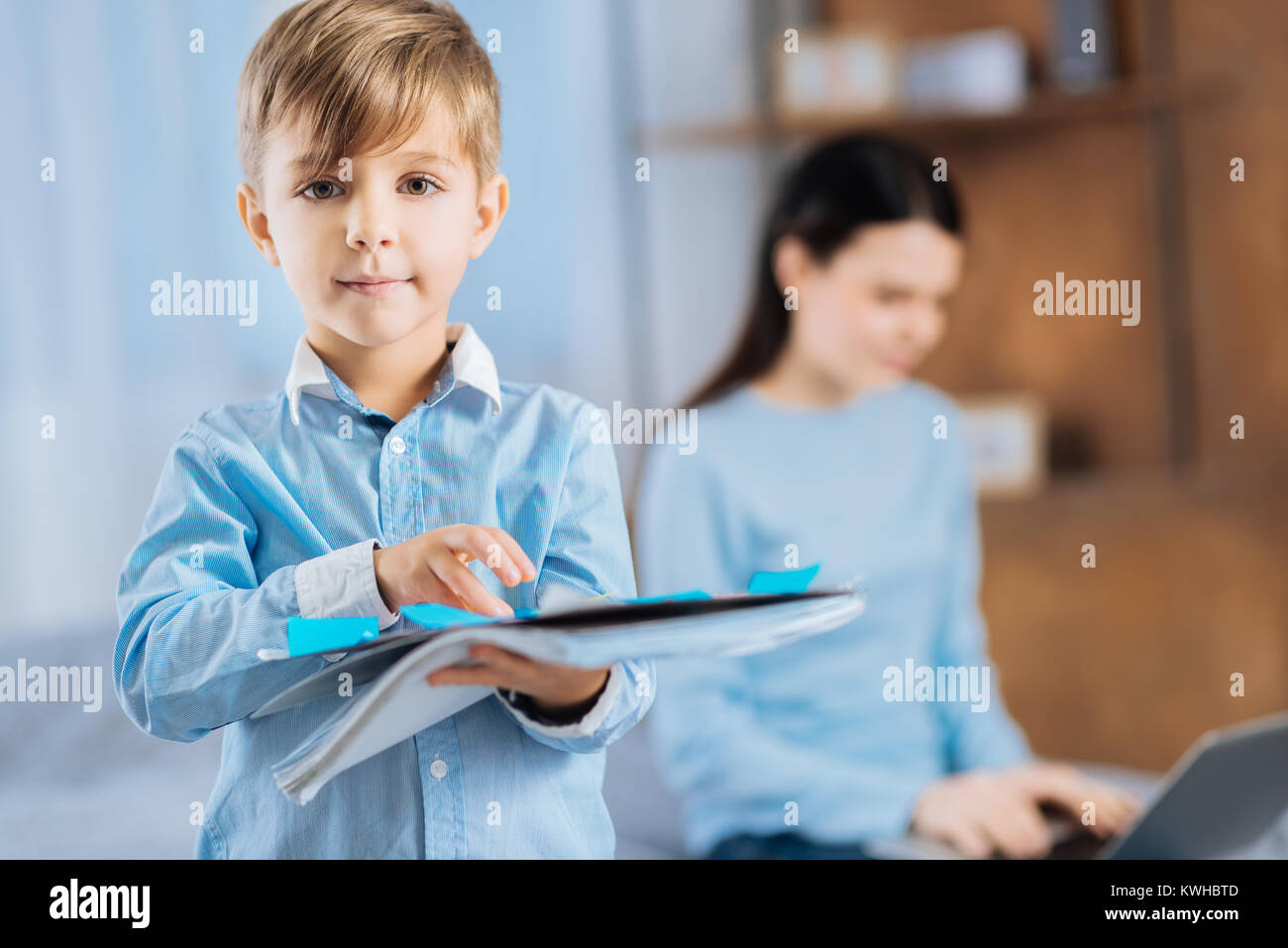 Adorable boy holding notebook with his notes Stock Photo - Alamy