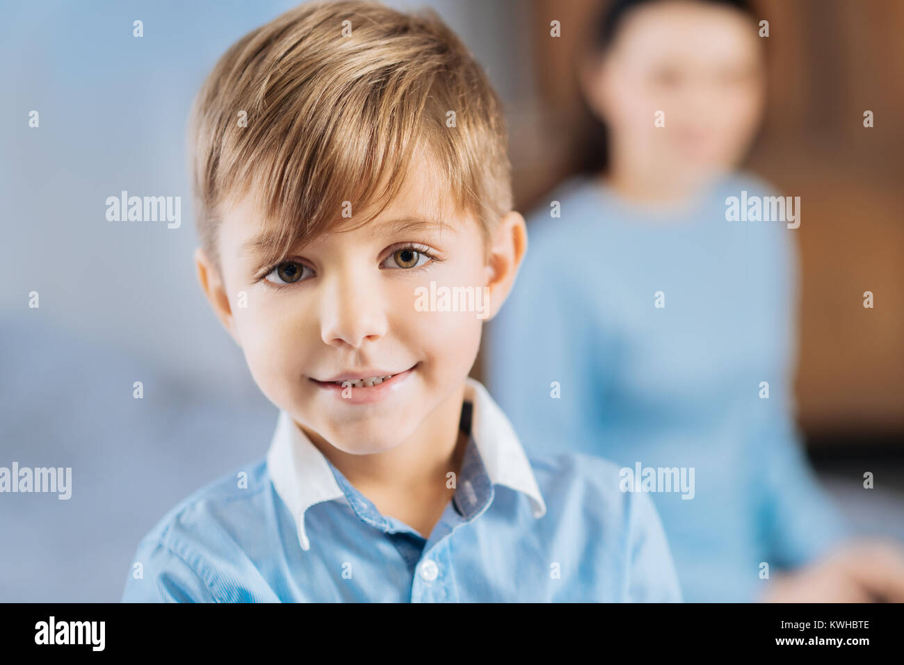 Portrait of a handsome fair-haired boy in a blue shirt Stock Photo - Alamy