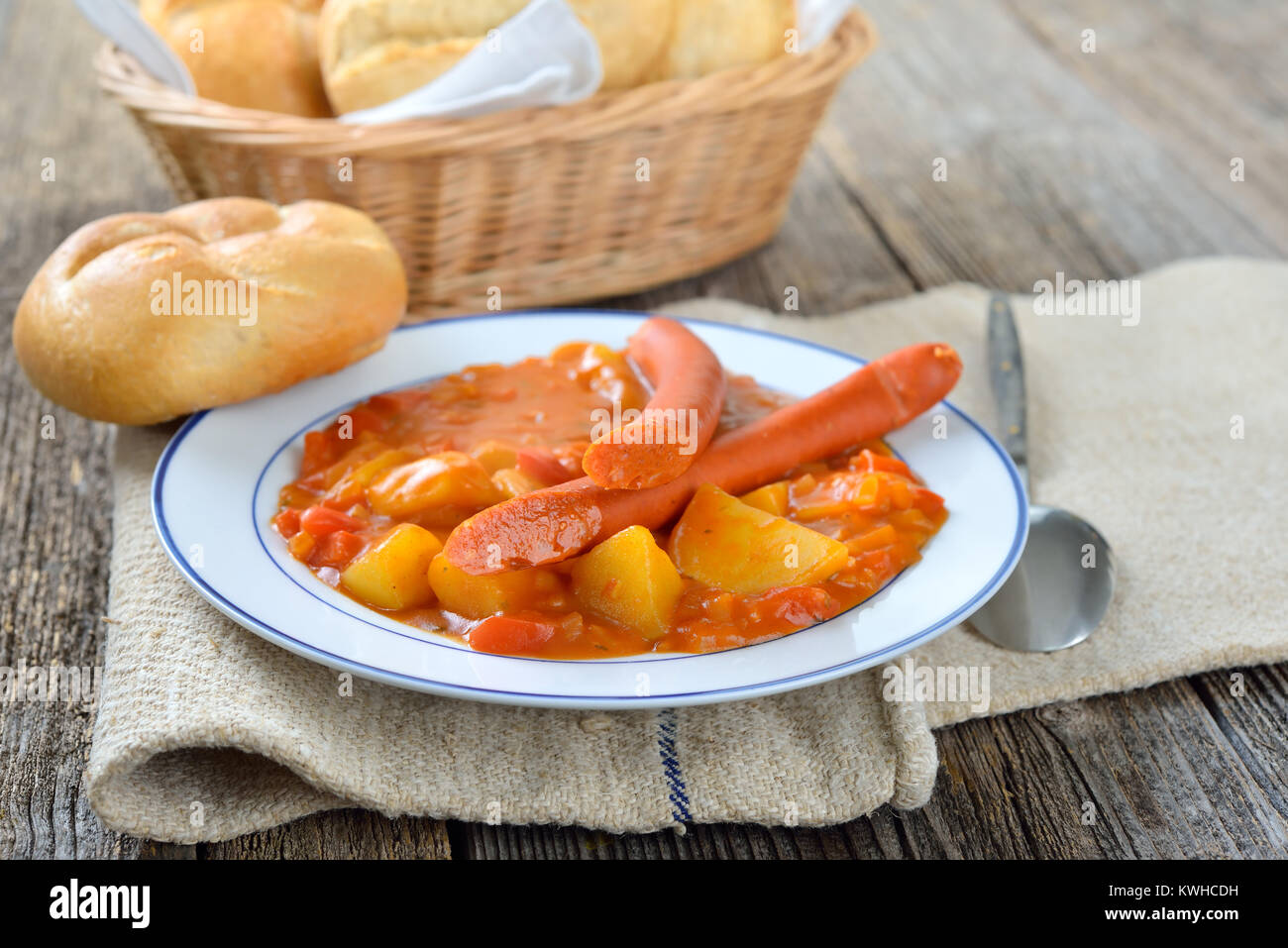 Hot potato goulash with Debreziner sausages and fresh rolls Stock Photo ...
