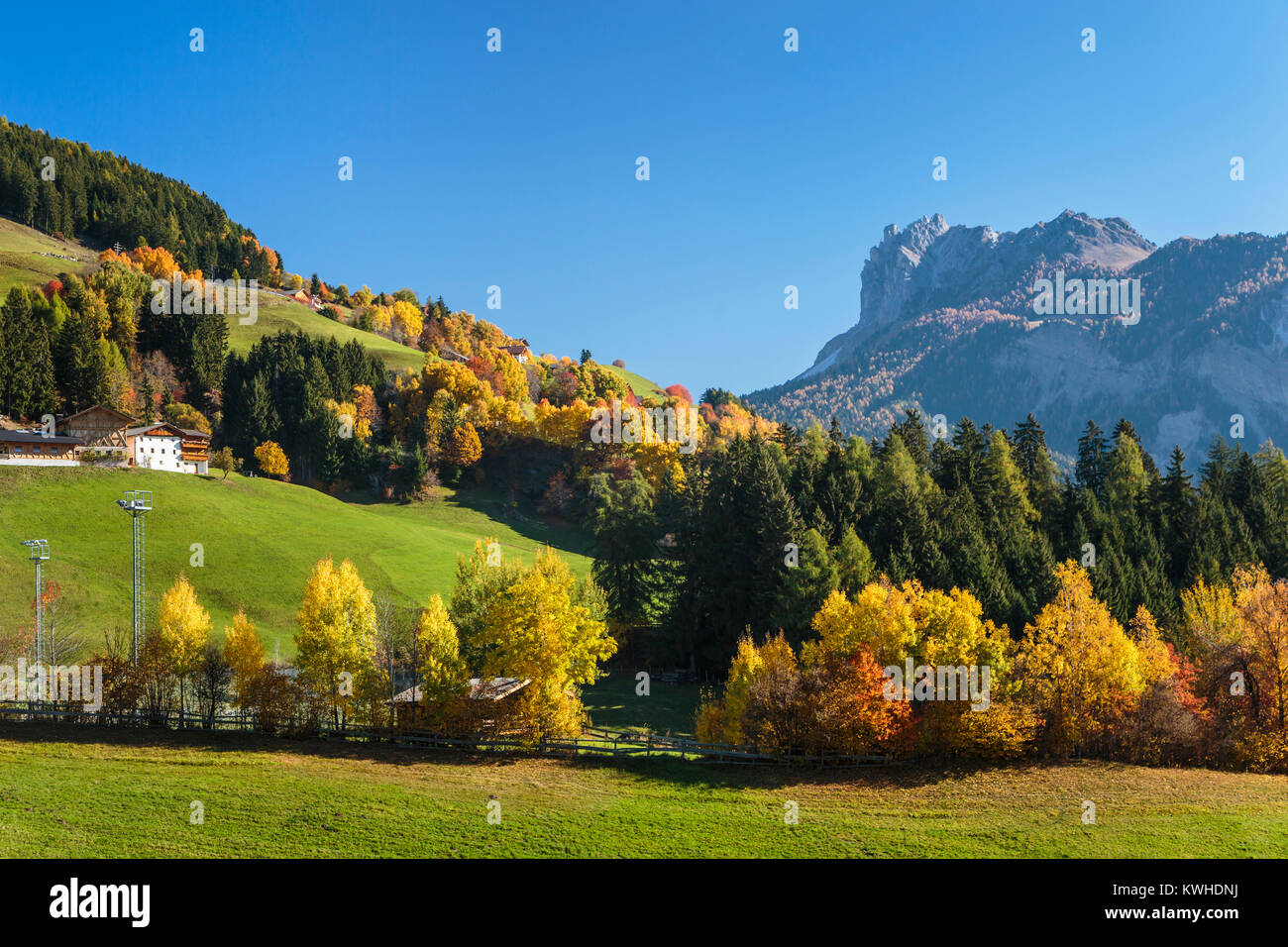 The Dolomite mountain range with fall foliage color near San Pietro ...