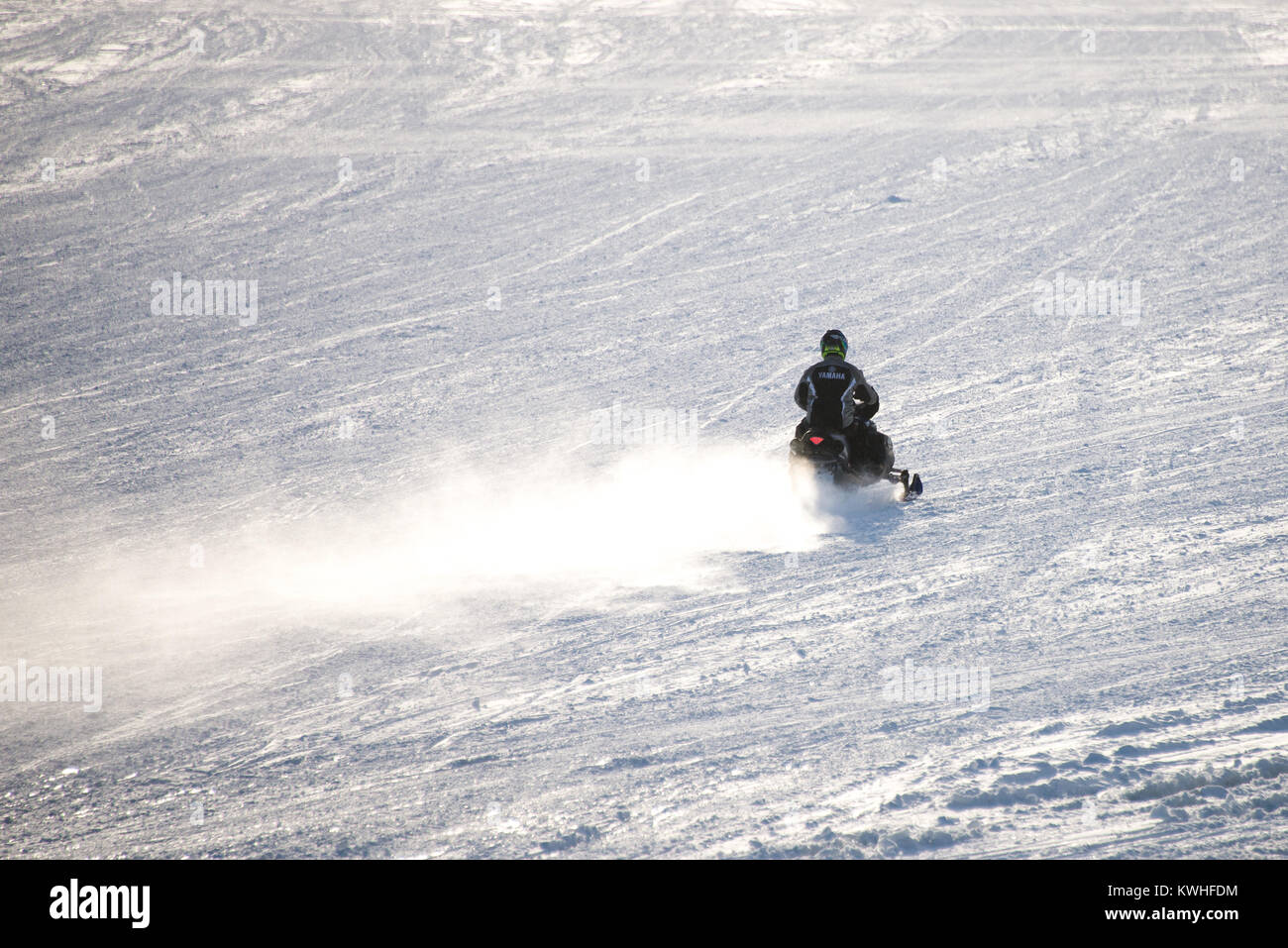 Snowmobile racing across a snow covered frozen Lake Pleasant in the ...