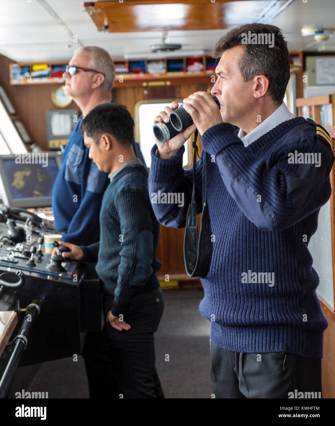 Ship's crew on bridge sailing passenger ship Ocean Adventurer; carries ...