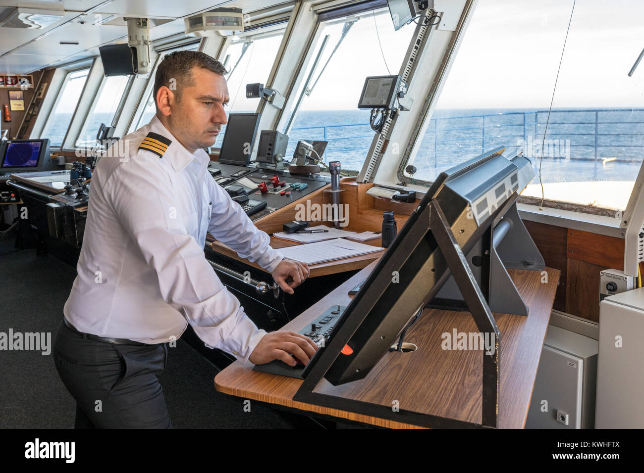 Ship's crew on bridge sailing passenger ship Ocean Adventurer; carries ...