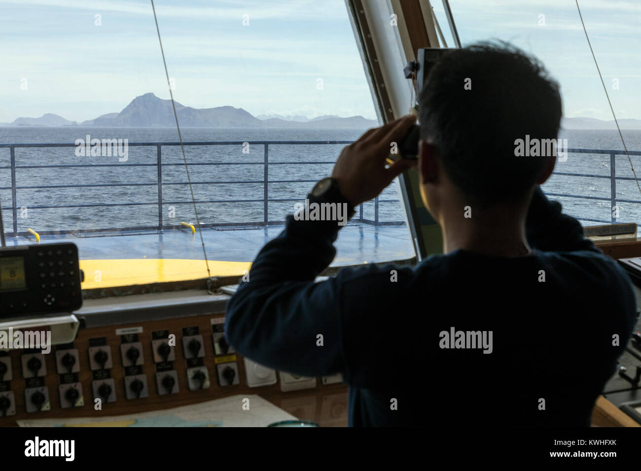 Ship's crew on bridge sailing passenger ship Ocean Adventurer; carries ...