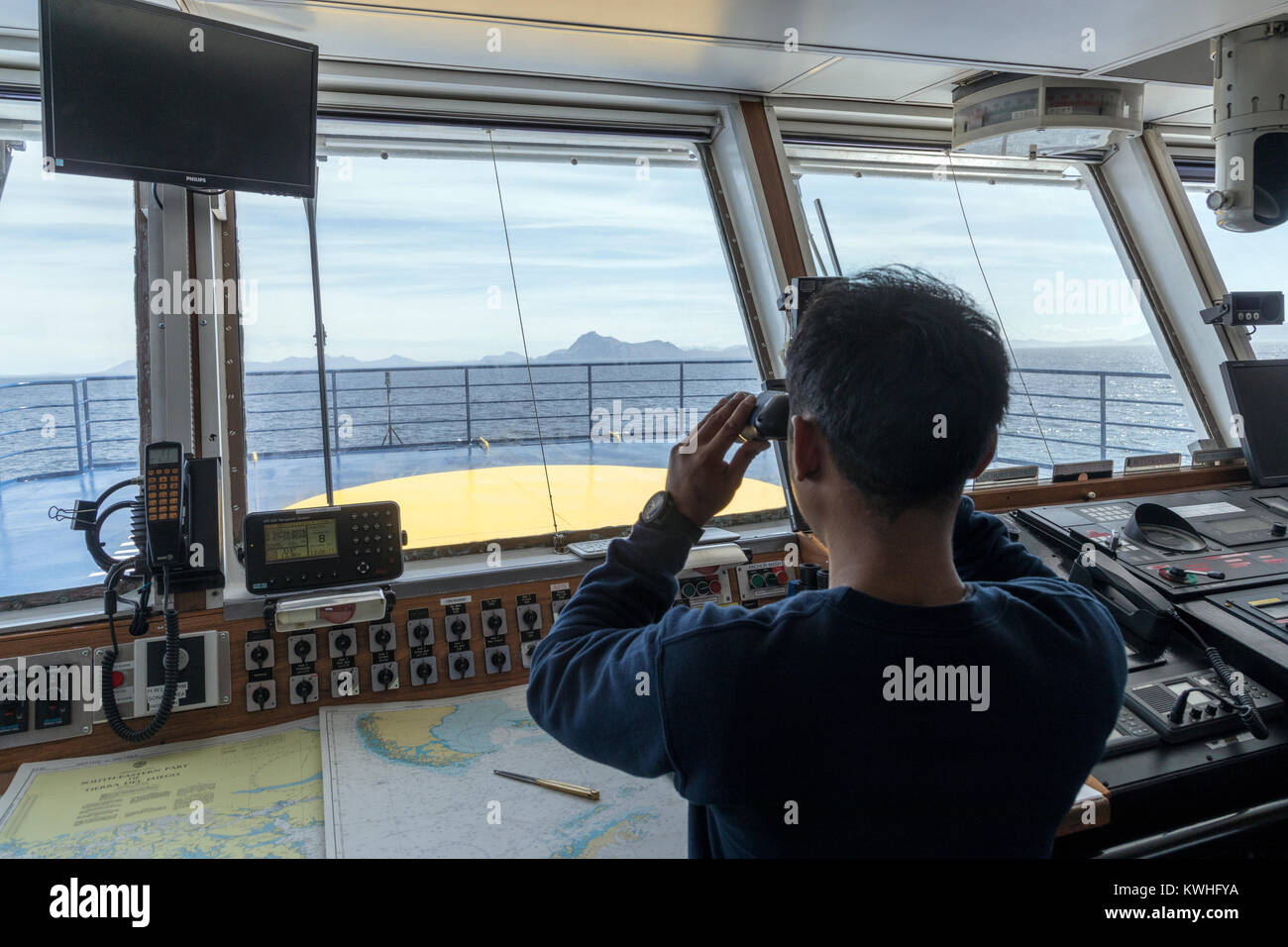 Ship's crew on bridge sailing passenger ship Ocean Adventurer; carries ...
