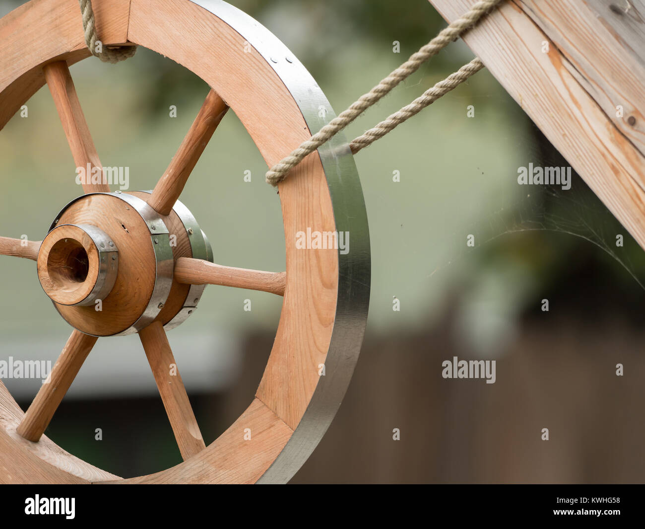 A wooden wheel hangs out as a decoration Stock Photo - Alamy