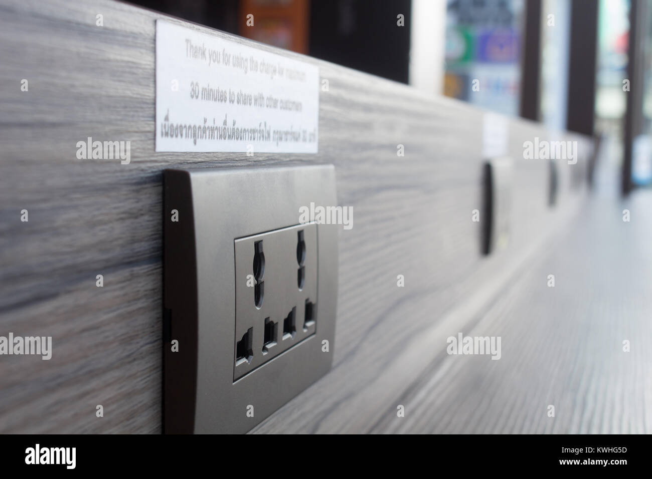 Power plug for charging mobile phone in a coffee shop in Thailand Stock ...