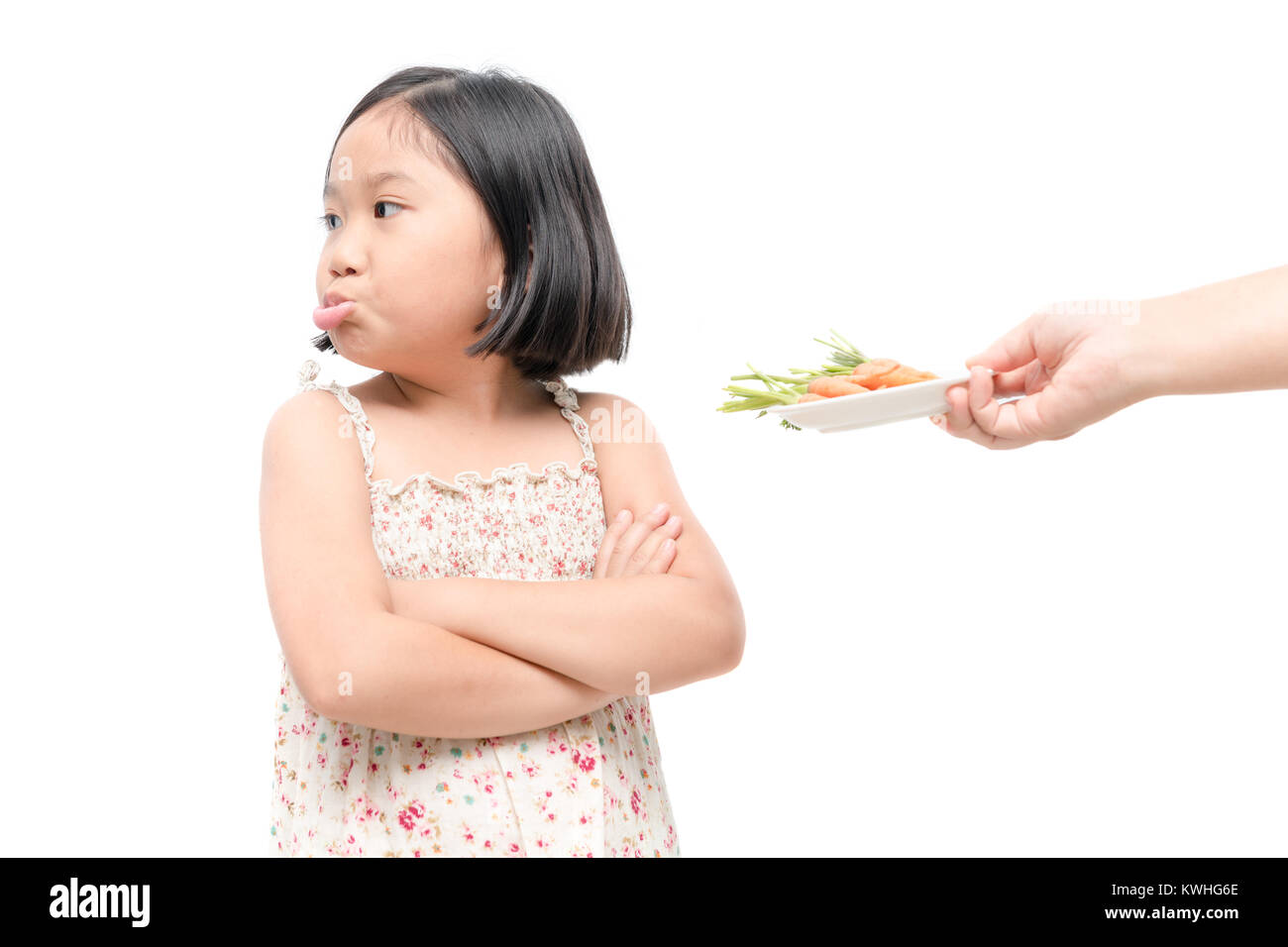 asian child girl with expression of disgust against vegetables isolated ...