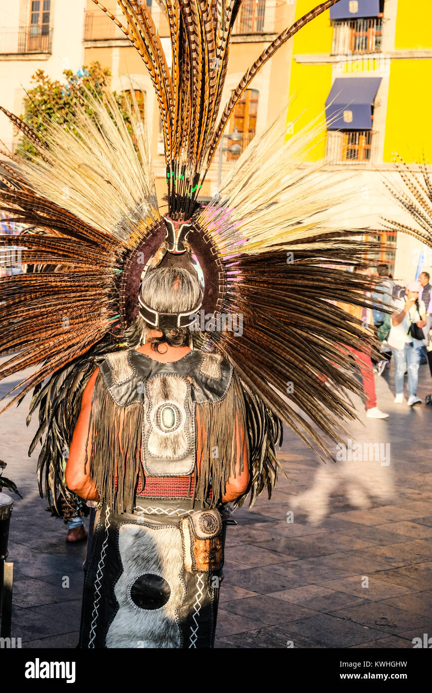 Indigenous people in traditional costumes and headdresses perform at ...