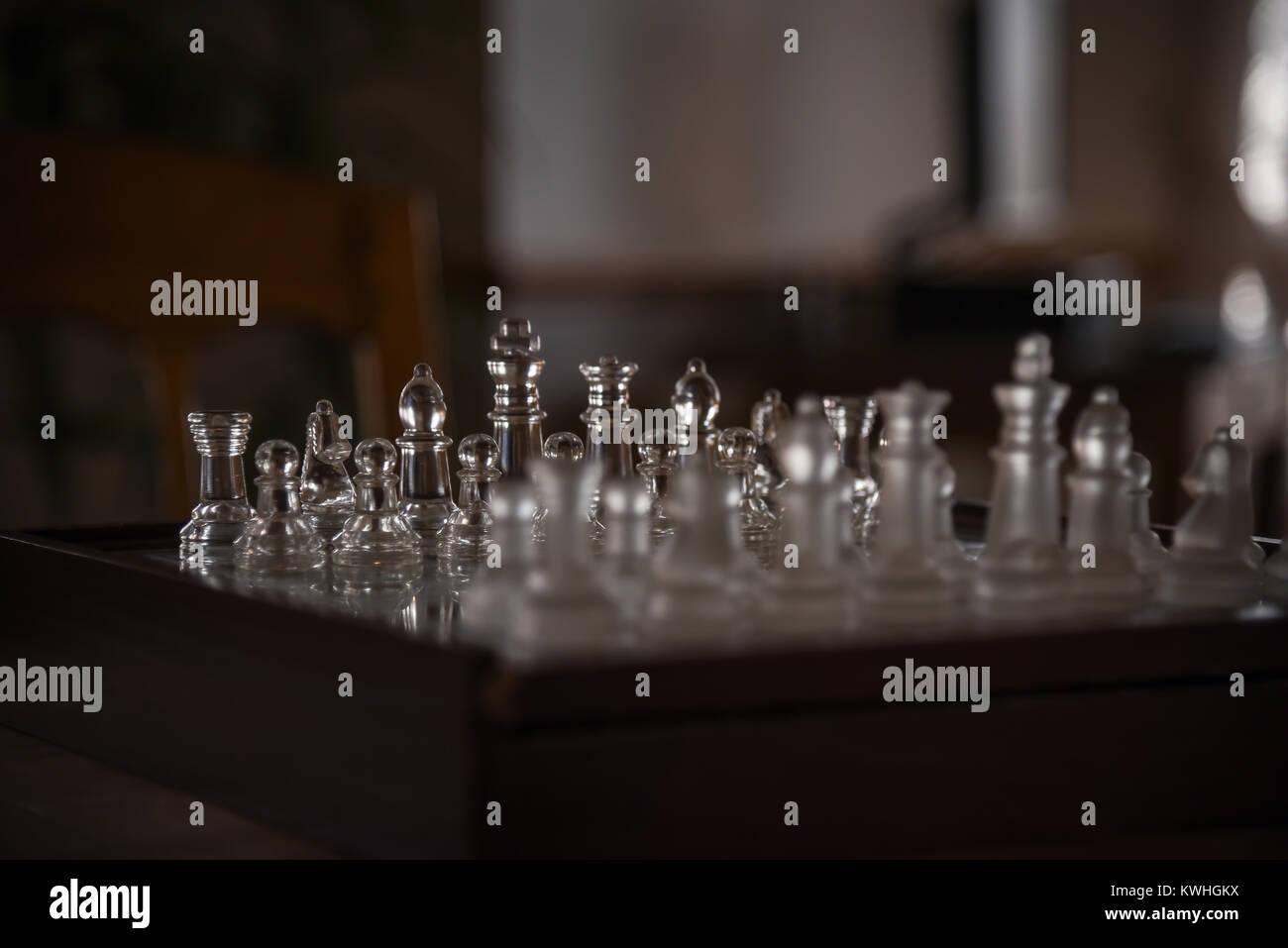 chess board with glass pieces set up for game Stock Photo - Alamy