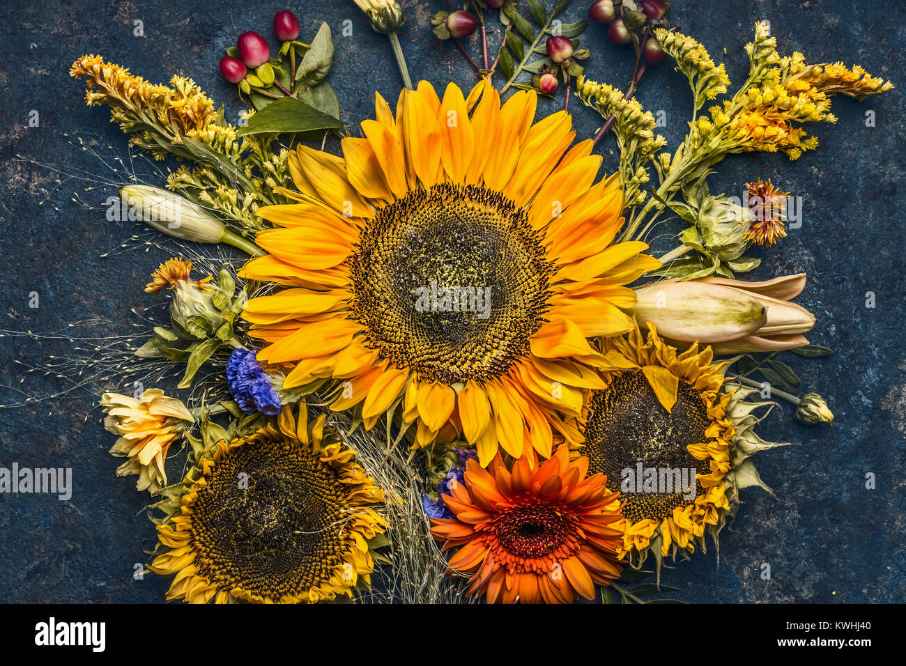 Autumn flowers and leaves composition with sunflowers on dark rustic ...