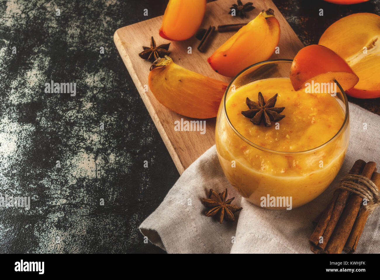 Persimmon fruit smoothie with cinnamon and anise stars, dark rusty ...