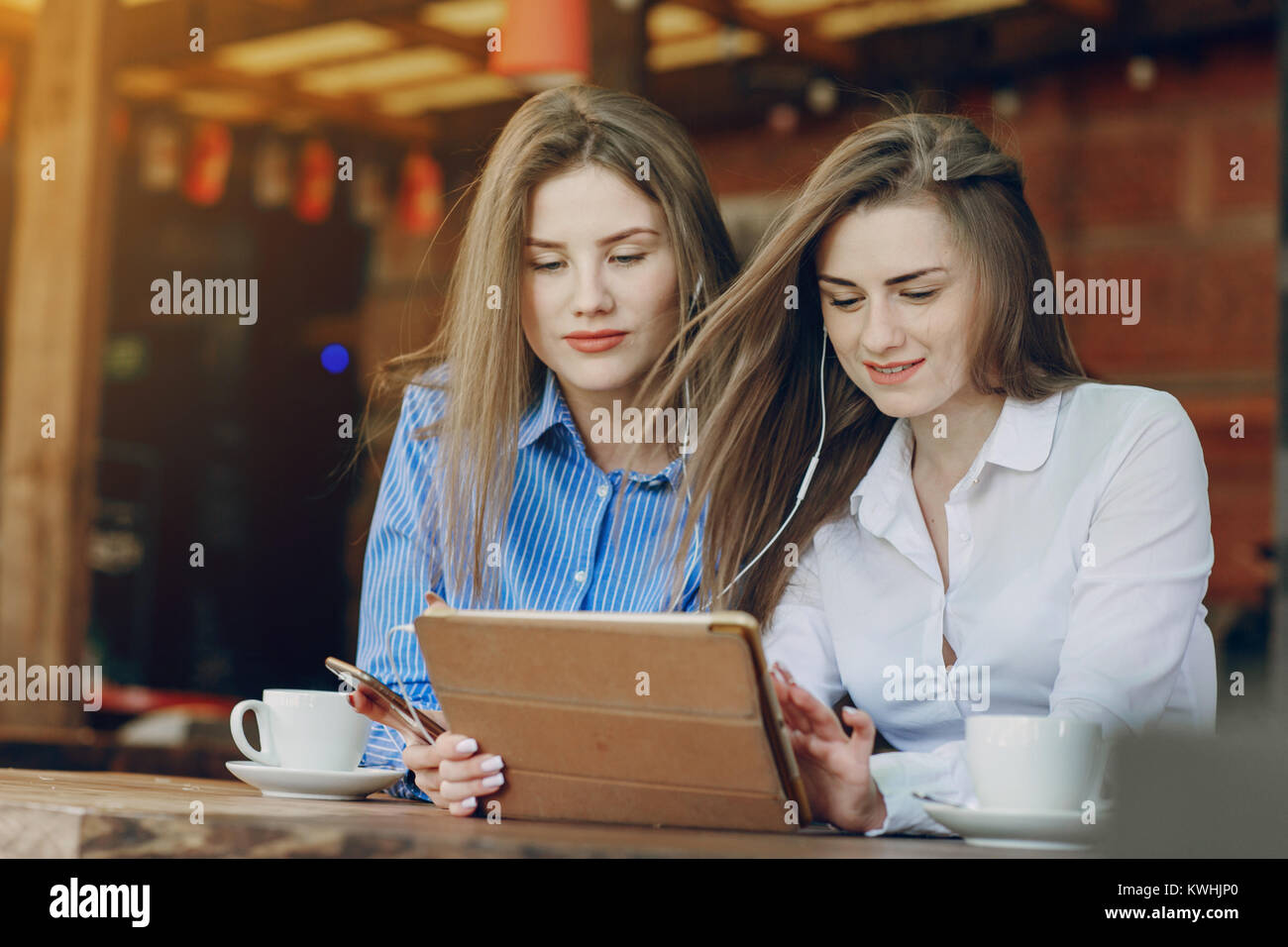 two girls in a cafe Stock Photo - Alamy