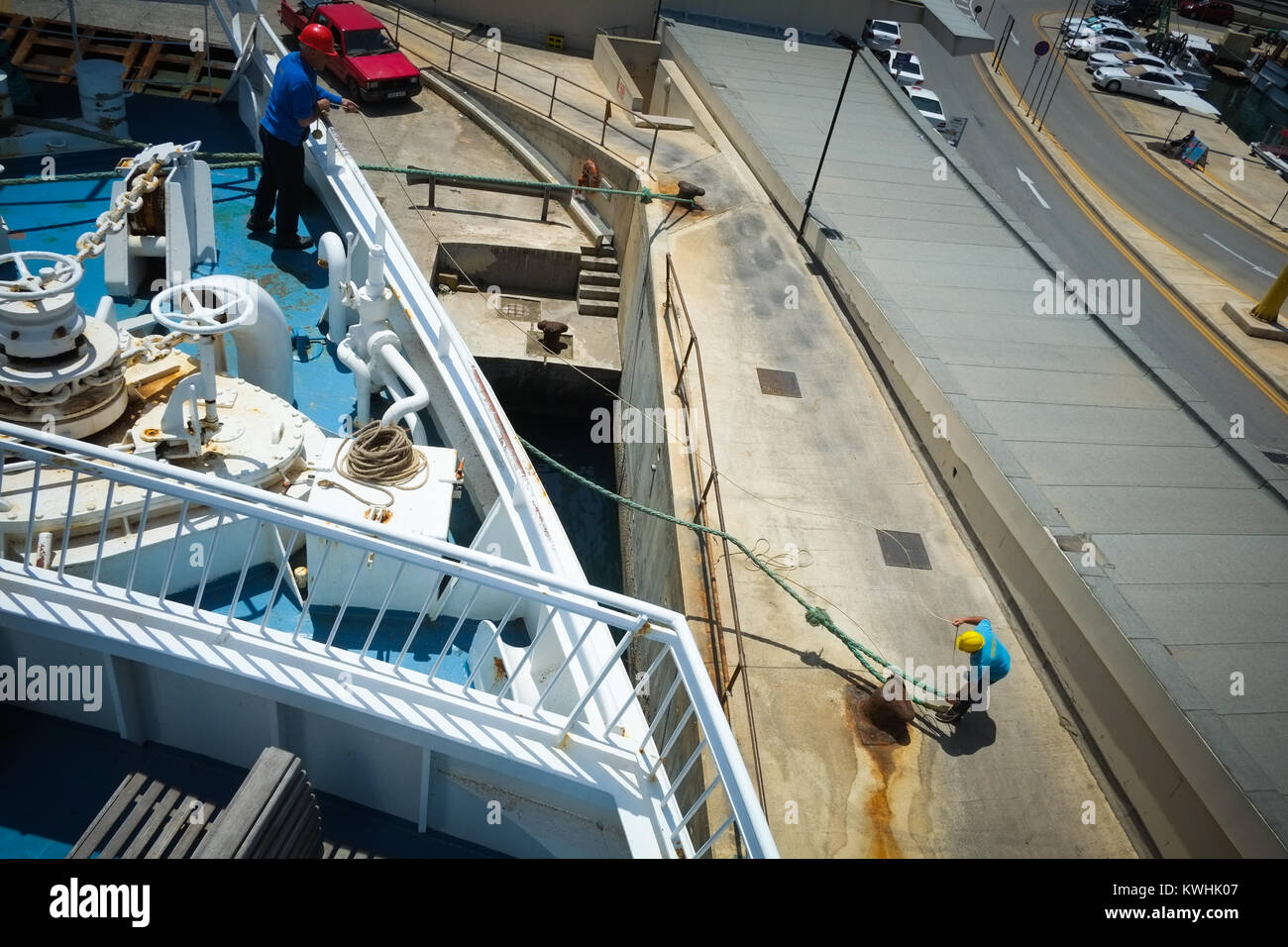 Two men working on the Gozo Channel Company ferry as it arrives into ...