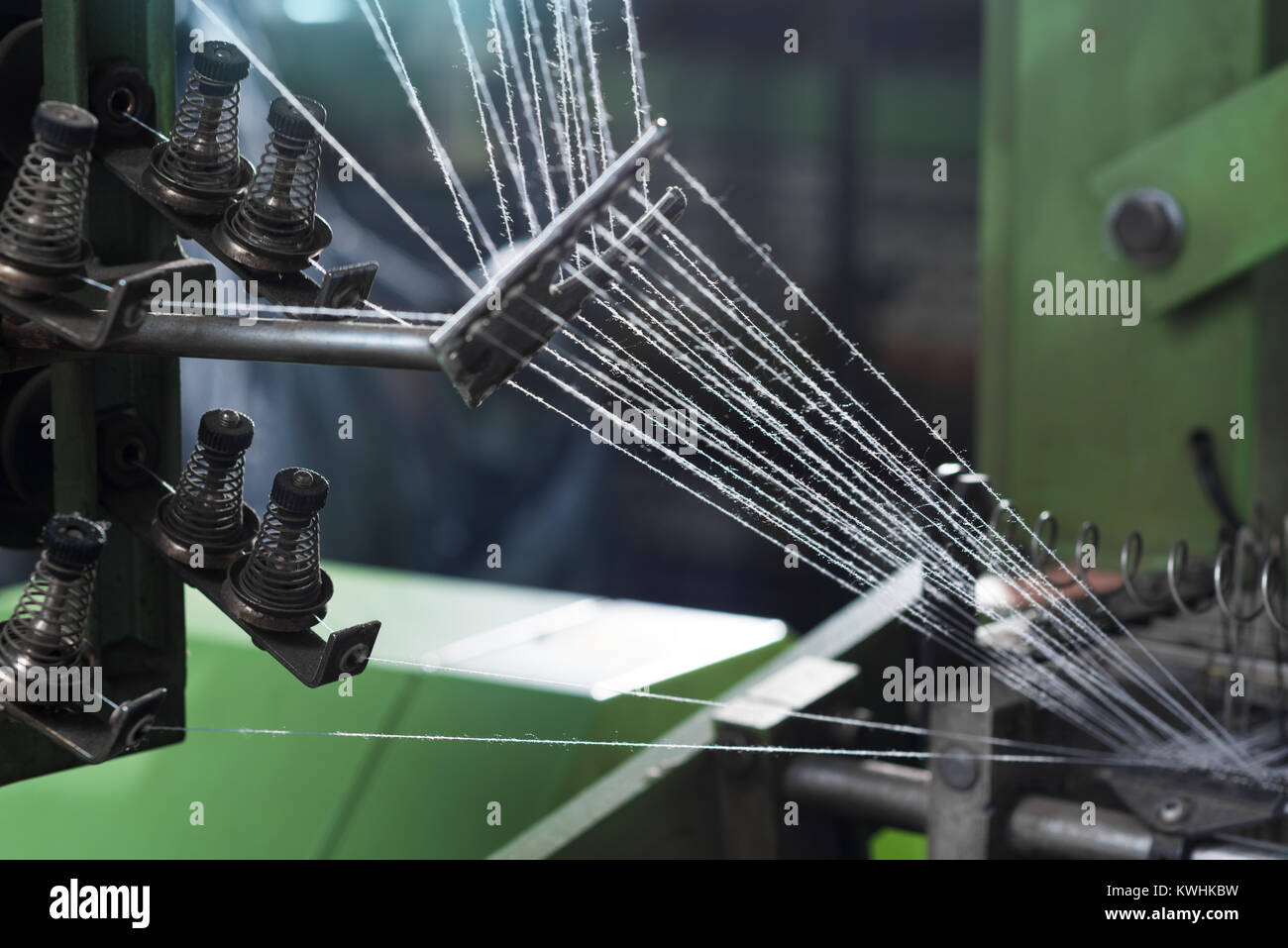 Yarns in label weaving machine Stock Photo - Alamy