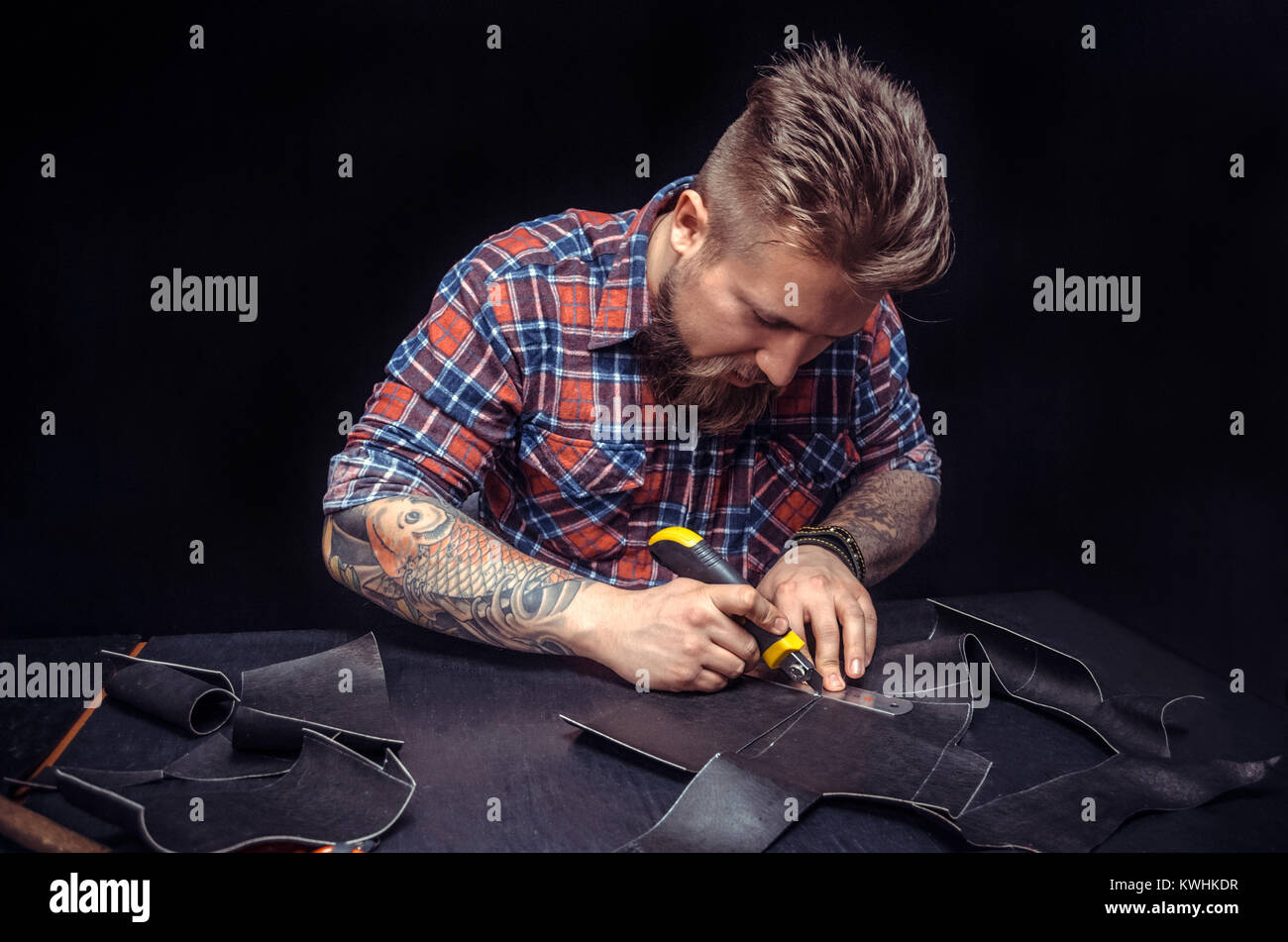 Leather Artist works with leatherwork Stock Photo - Alamy