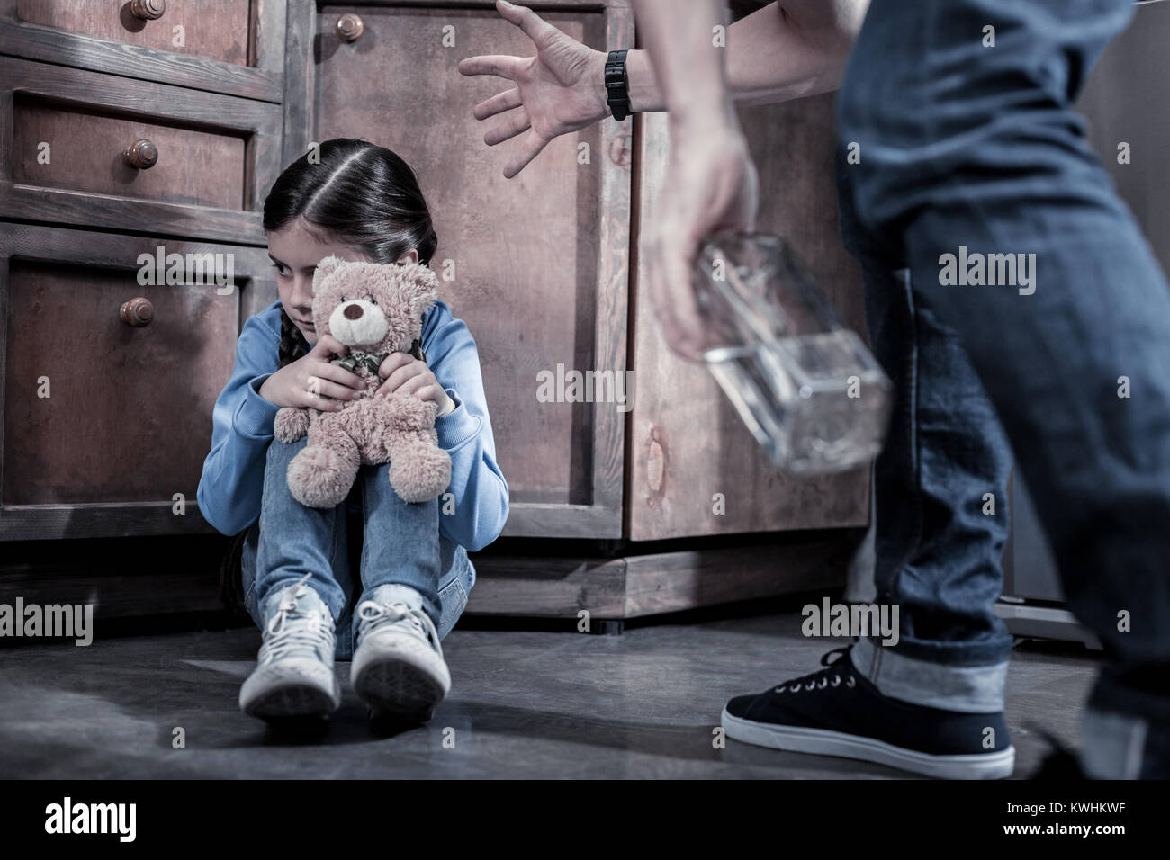 Sad scared girl holding her toy Stock Photo - Alamy