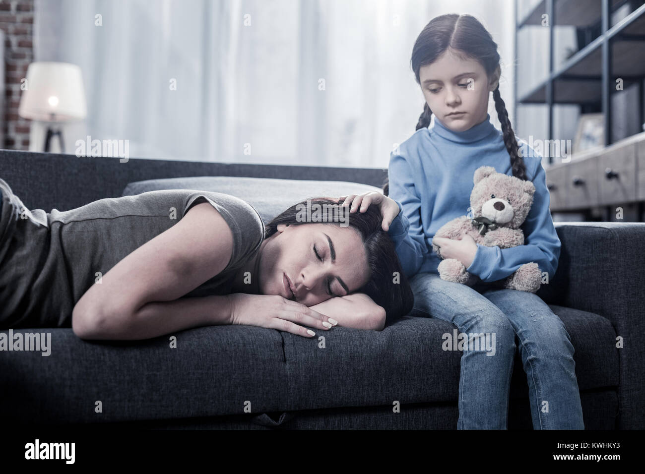 Pleasant nice girl caring about her mother Stock Photo - Alamy