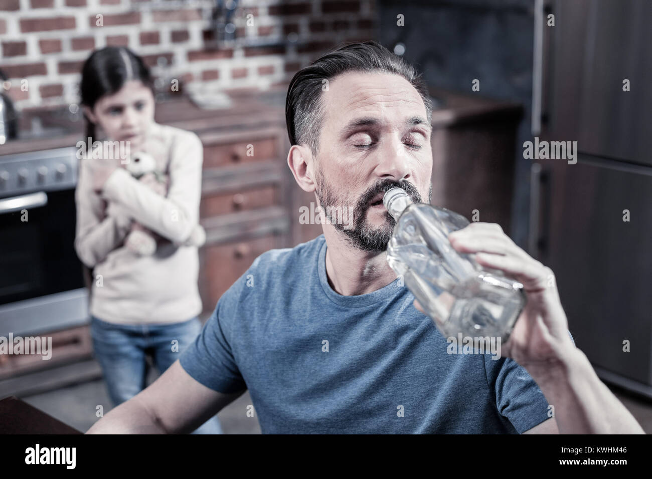 Unhappy cheerless man drinking vodka Stock Photo - Alamy