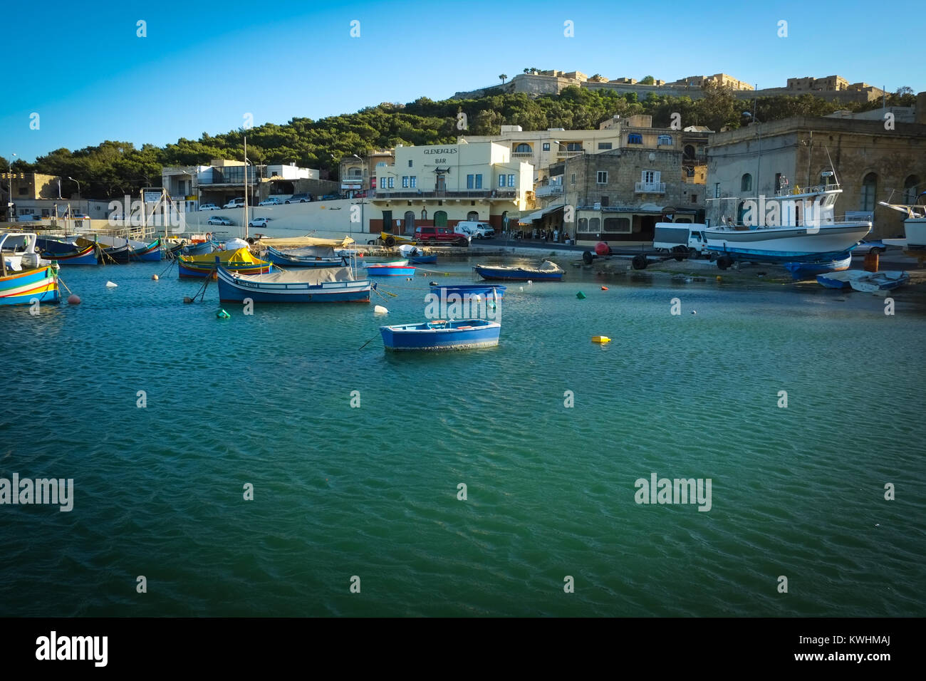 Mgarr harbour, Gozo in the evening light with traditional Maltese ...