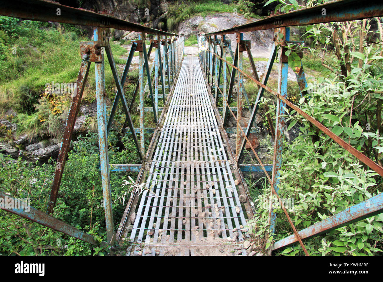 Rusty bridge and green leaves in Nepal Stock Photo - Alamy