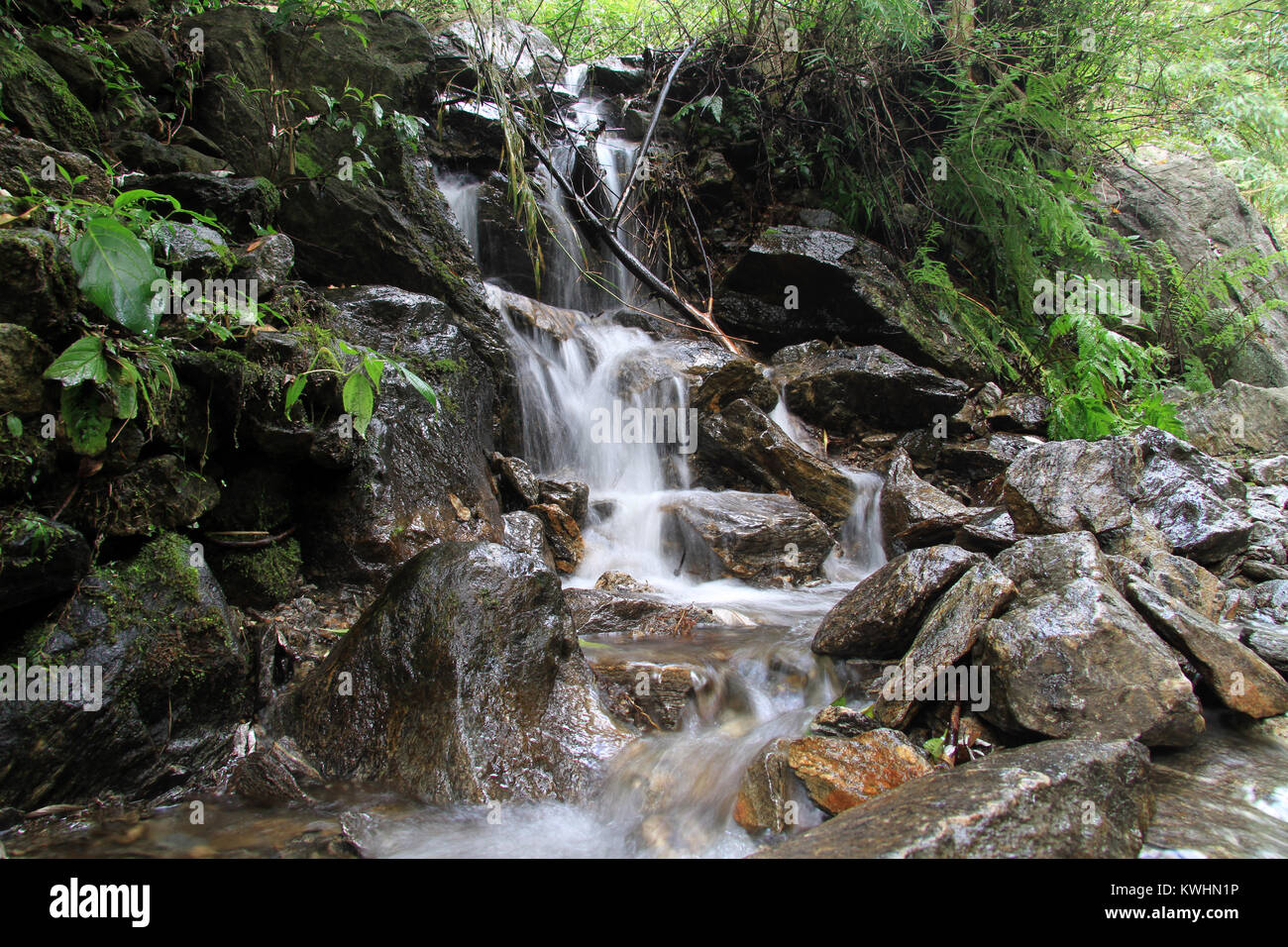 Smooth waterfall and rocks in Nepal Stock Photo - Alamy