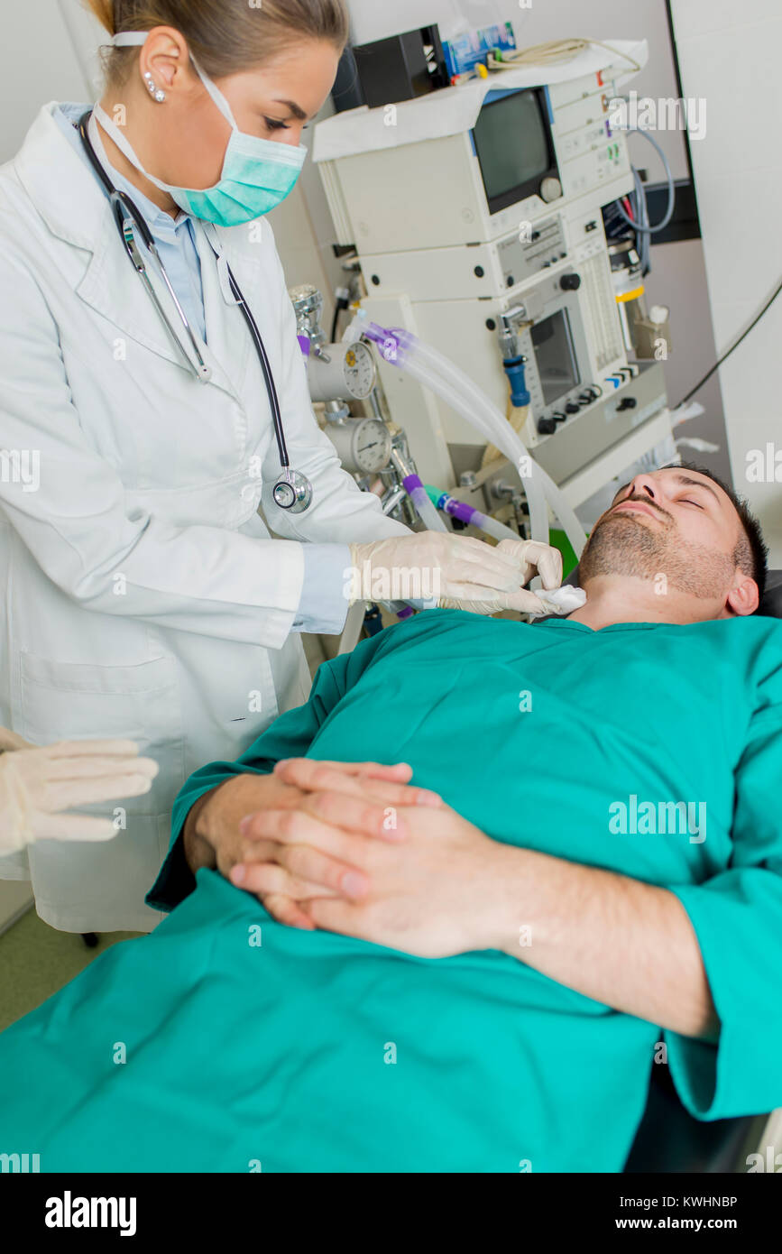 Nurses preparing patient before operation in operating room at hospital ...