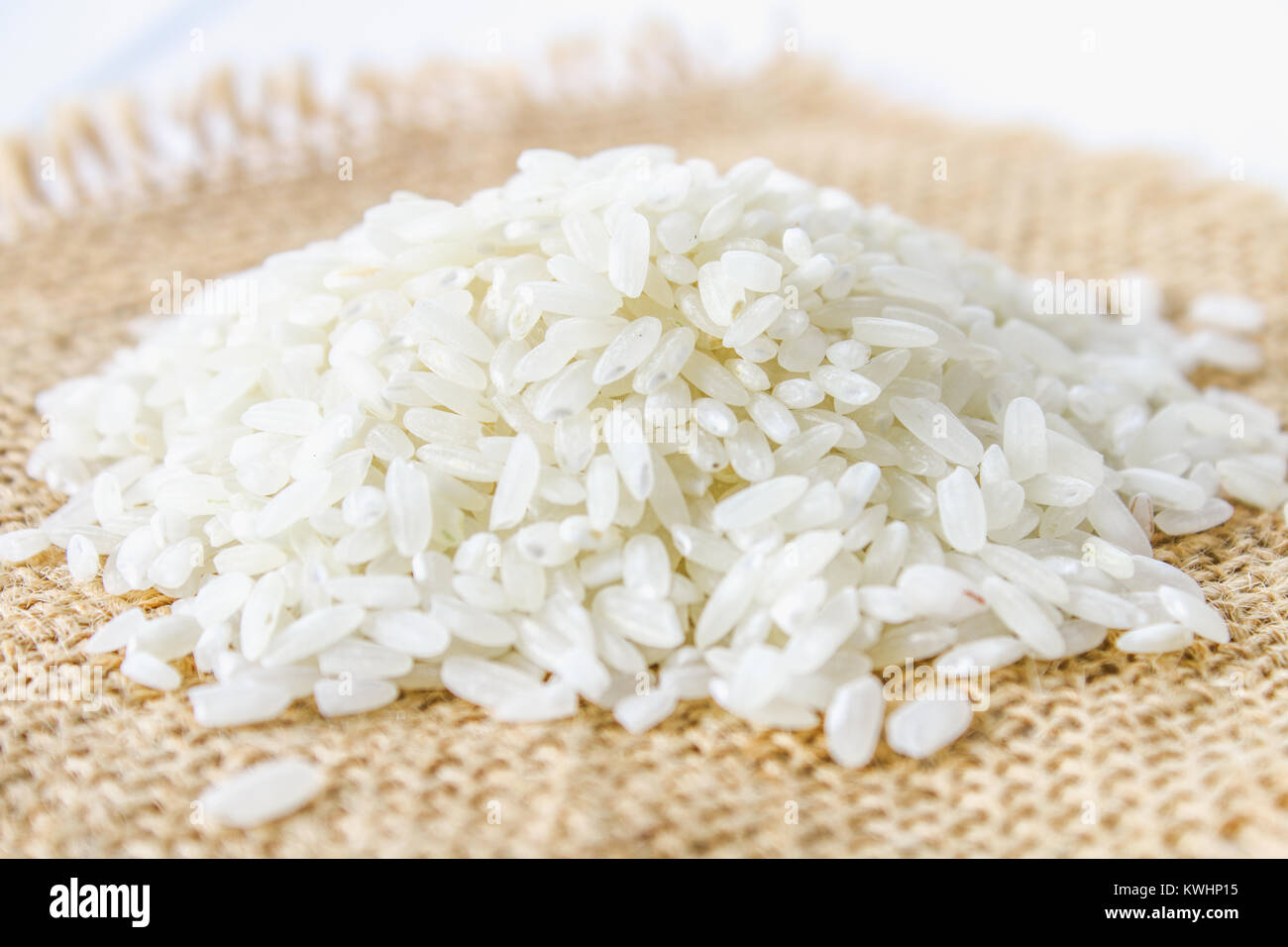 Grains of raw white rice on a white wooden table of boards. Ingredients ...