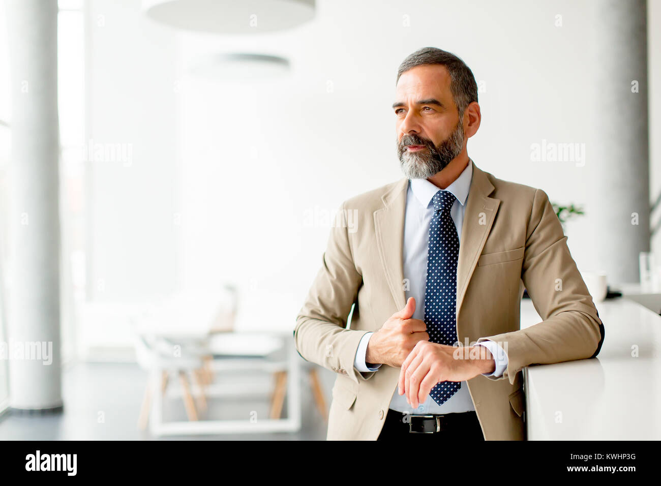 Handsome man standing in the office Stock Photo - Alamy