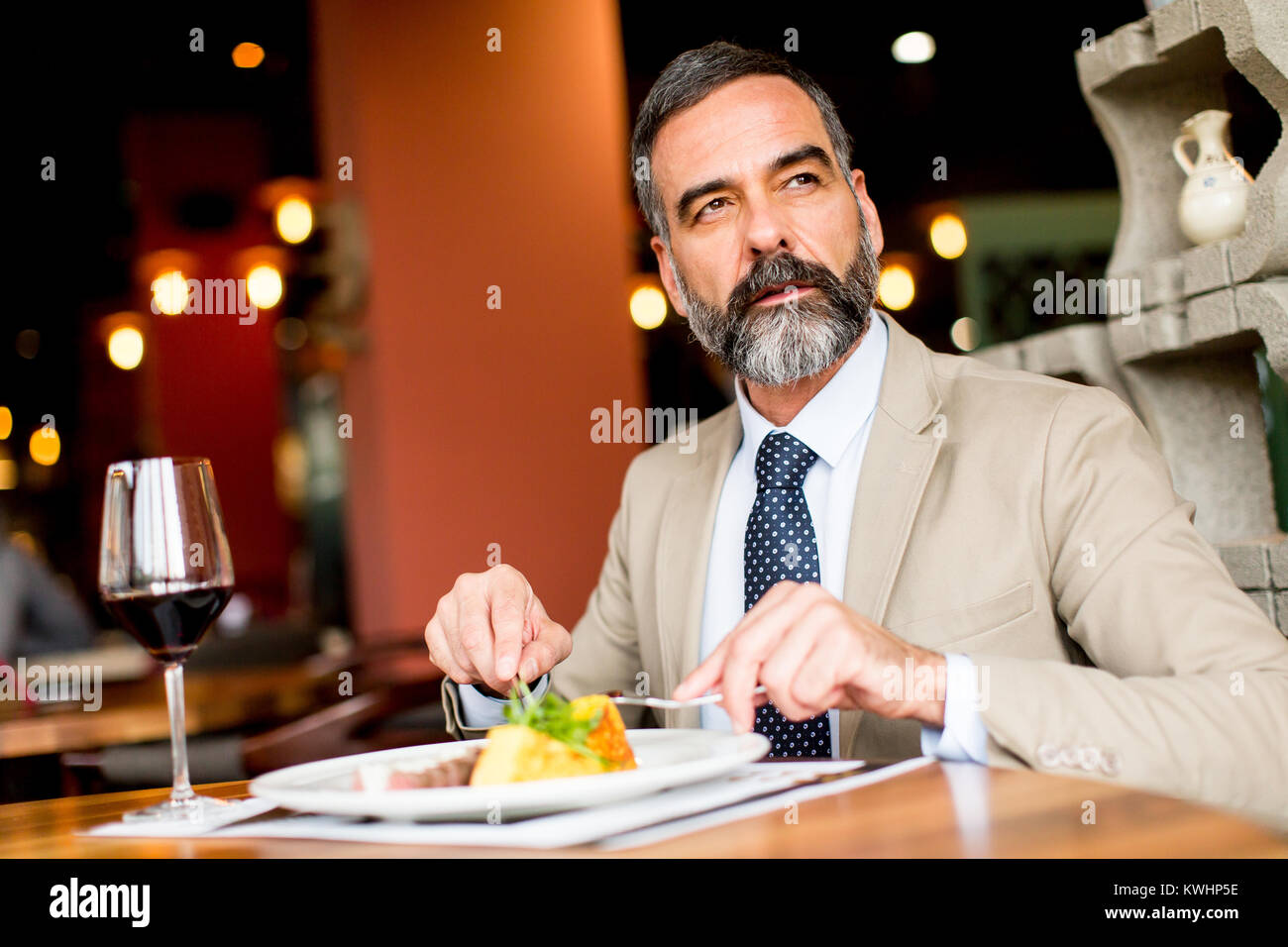 Portrait of senior man eating lunch in restaurant Stock Photo - Alamy