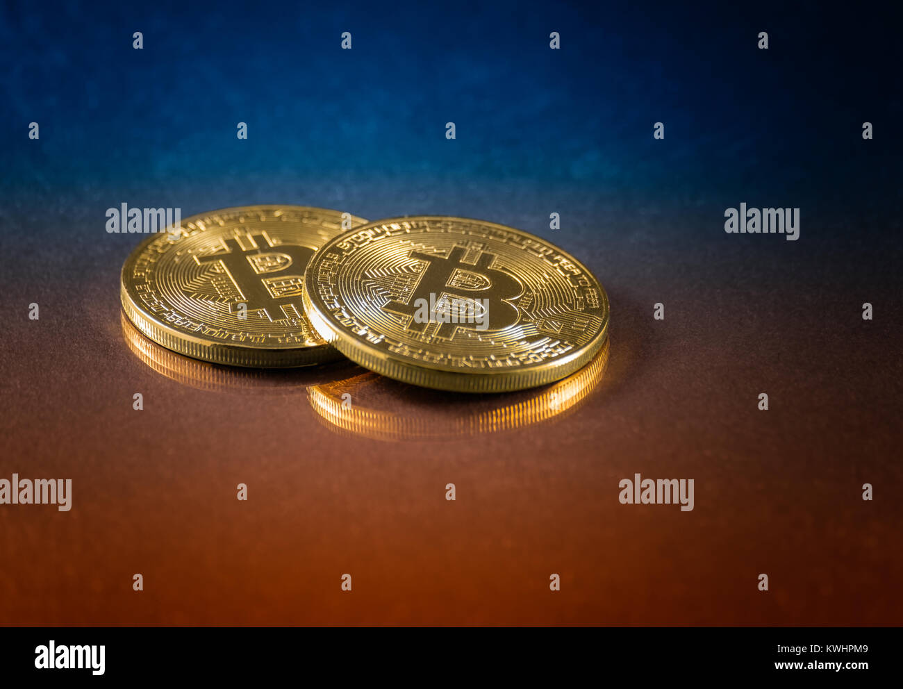 Cryptocurrency physical colored bitcoin coins. Two golden bitcoin with ...