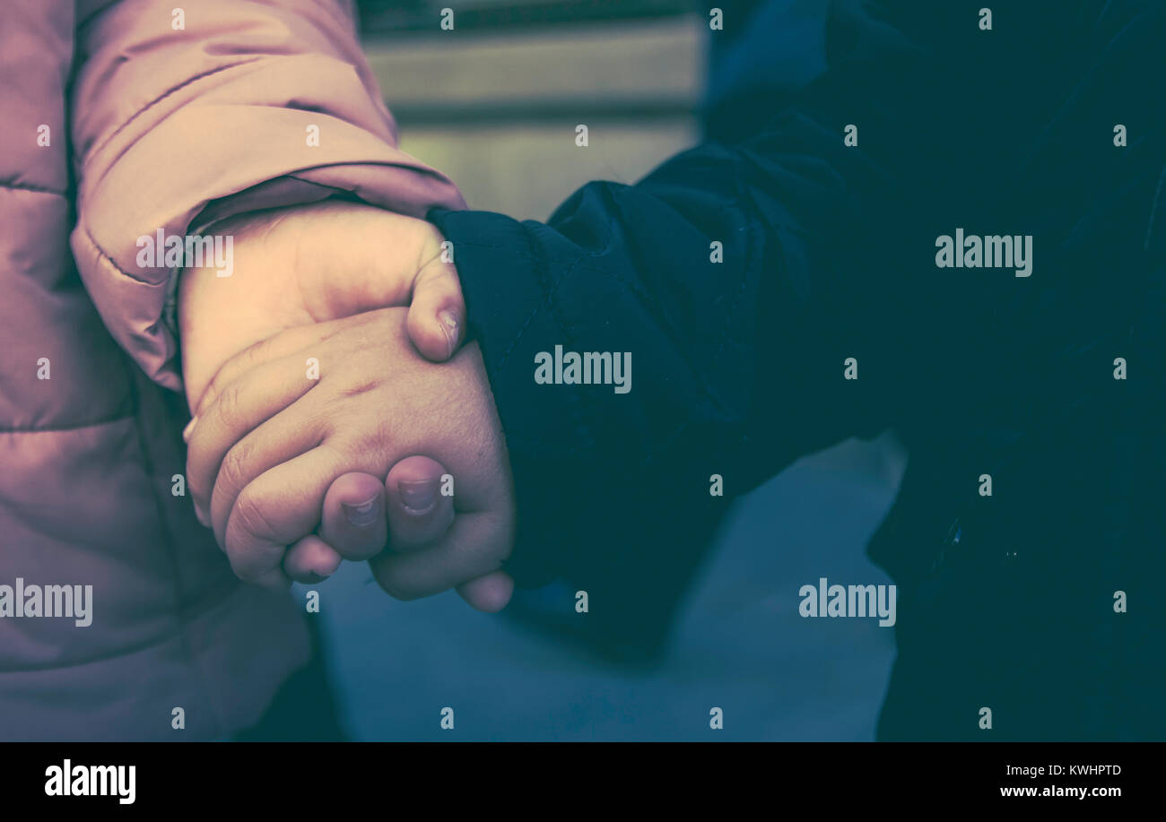 Two children holding hands Stock Photo - Alamy