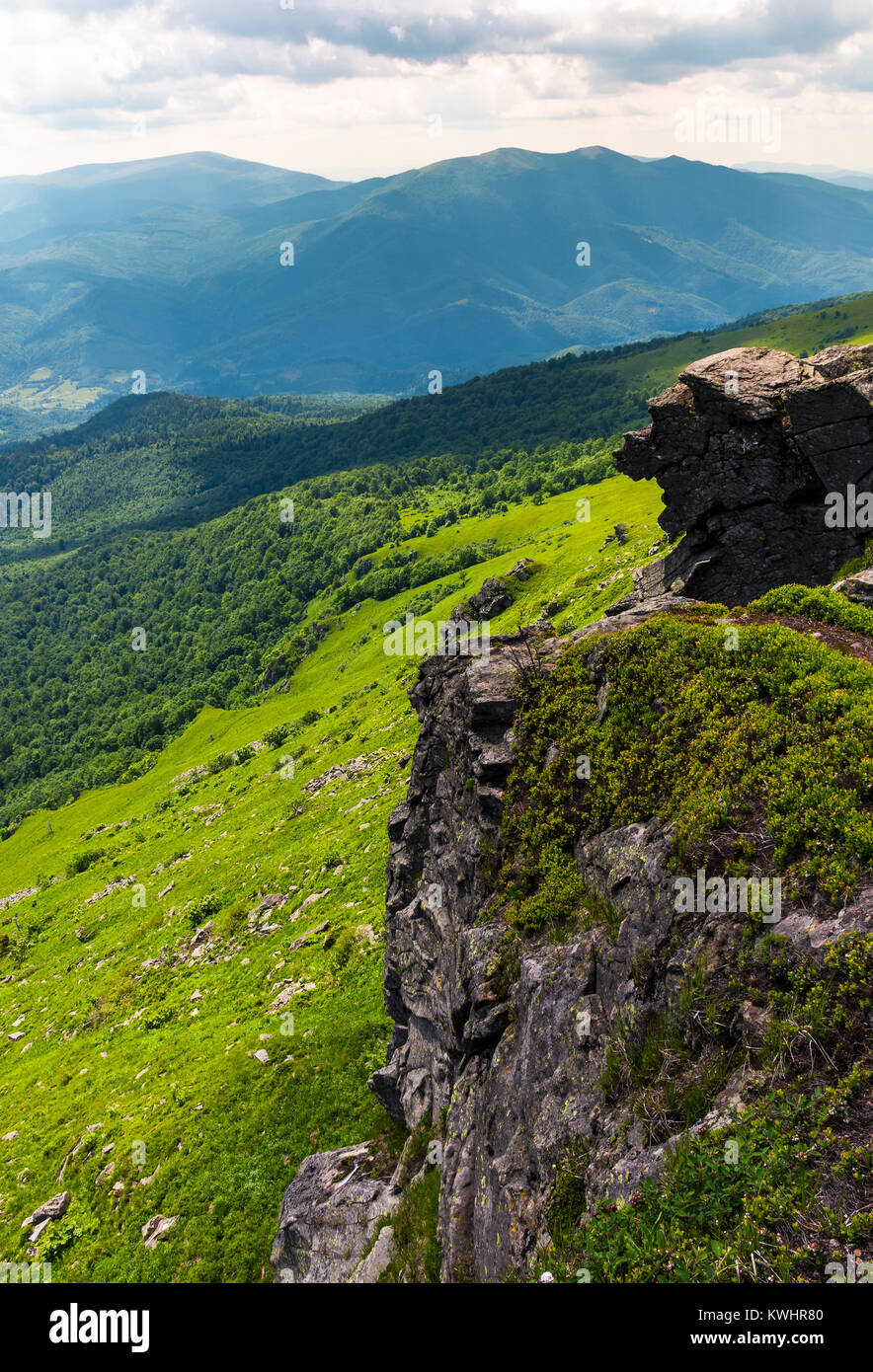 rocky cliff over the grassy valley. beautiful summer landscape with ...