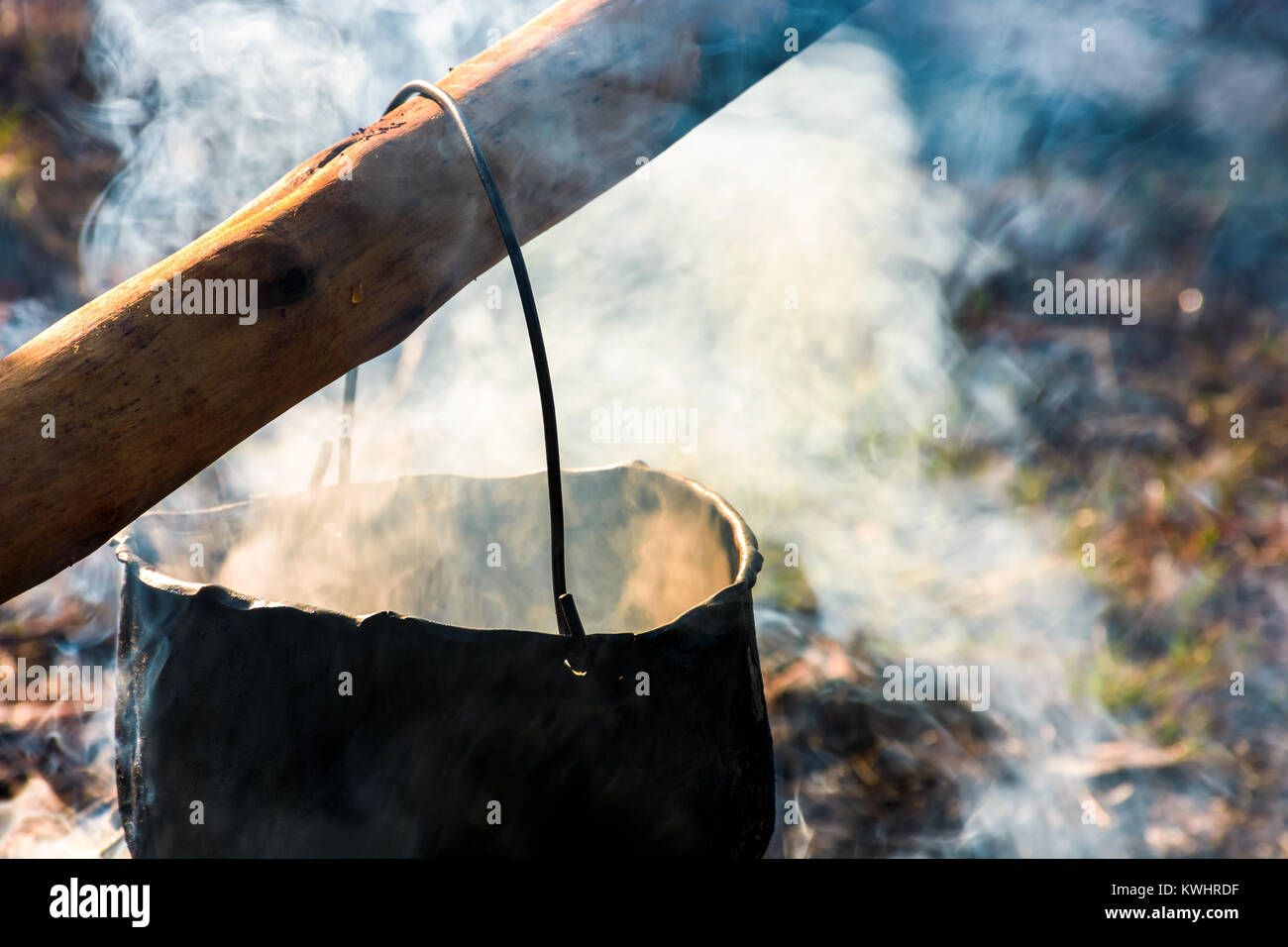 cauldron in steam and smoke on open fire. outdoor cooking concept. old ...