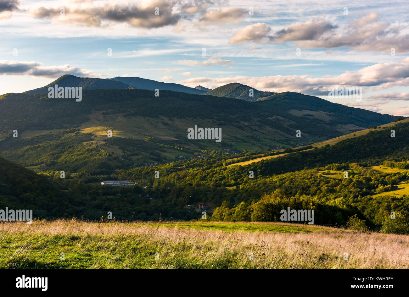 grassy slope in mountainous countryside at sunset. beautiful landscape ...