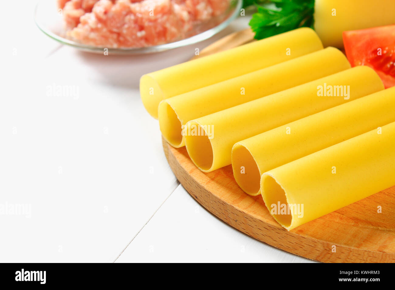 Italian pasta cannelloni. Raw tube for stuffing stuffing surrounded by ...