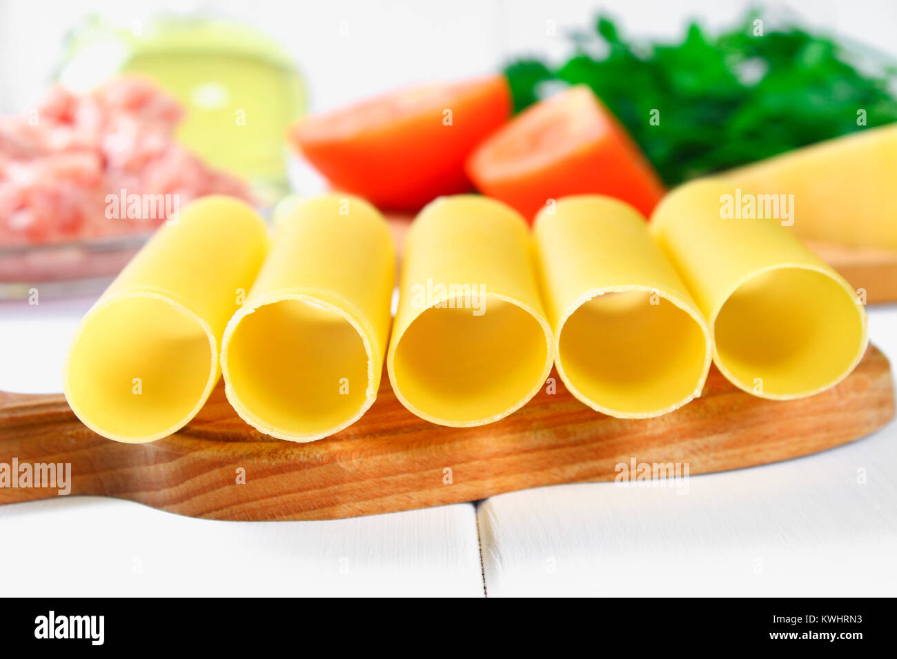 Italian pasta cannelloni. Raw tube for stuffing stuffing surrounded by ...
