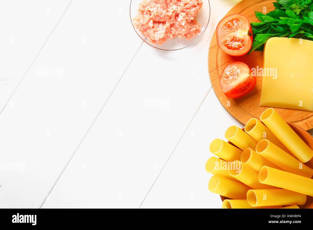 Italian pasta cannelloni. Raw tube for stuffing stuffing surrounded by ...