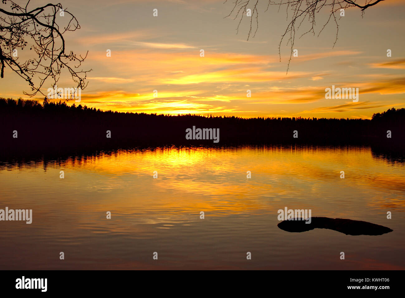 Beautiful colorful sunset reflecting from water surface Stock Photo - Alamy