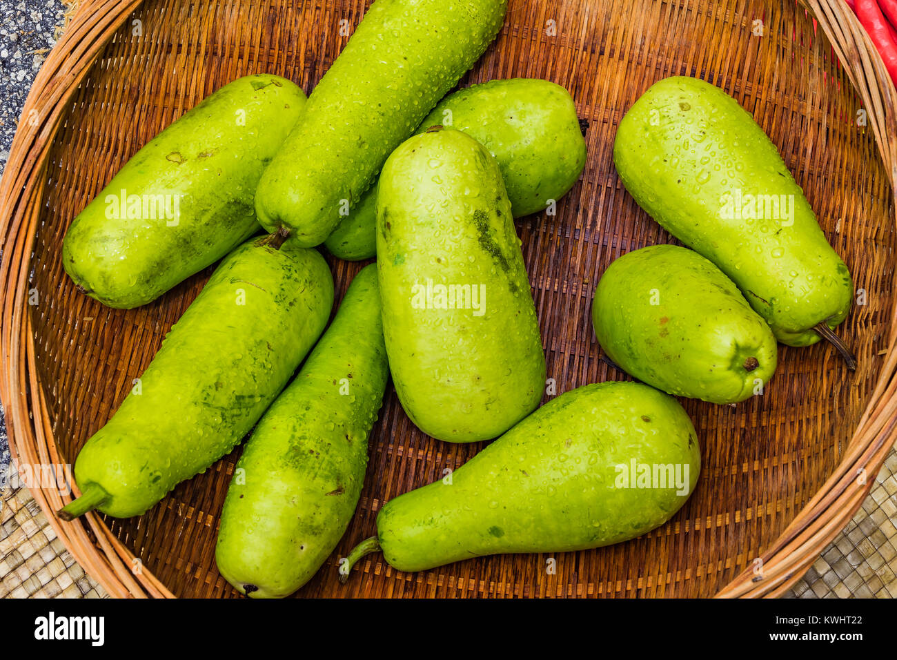 Bunch of fresh green melons in the tray on the wooden table background ...