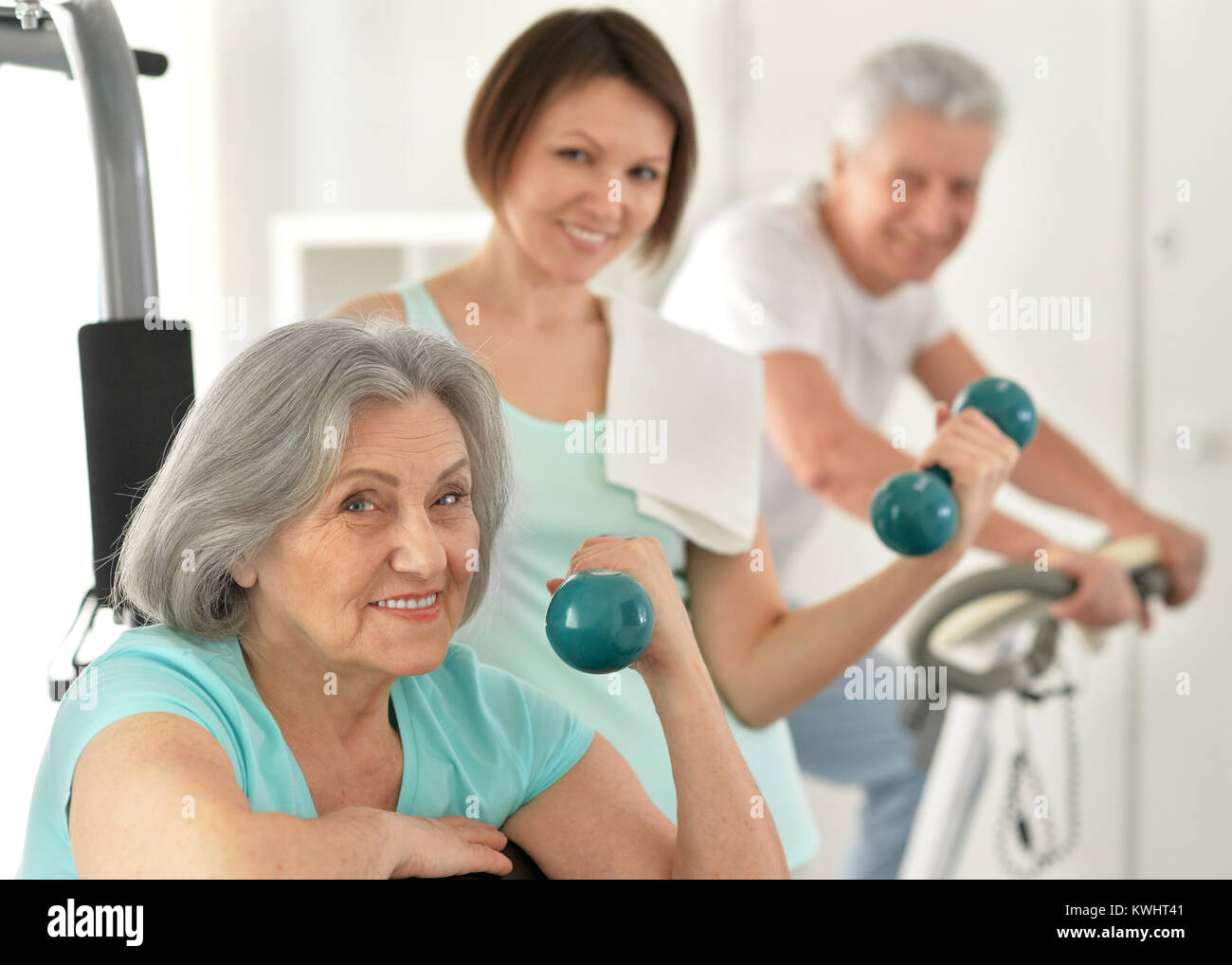 Portrait of active smiling people exercising in gym Stock Photo - Alamy
