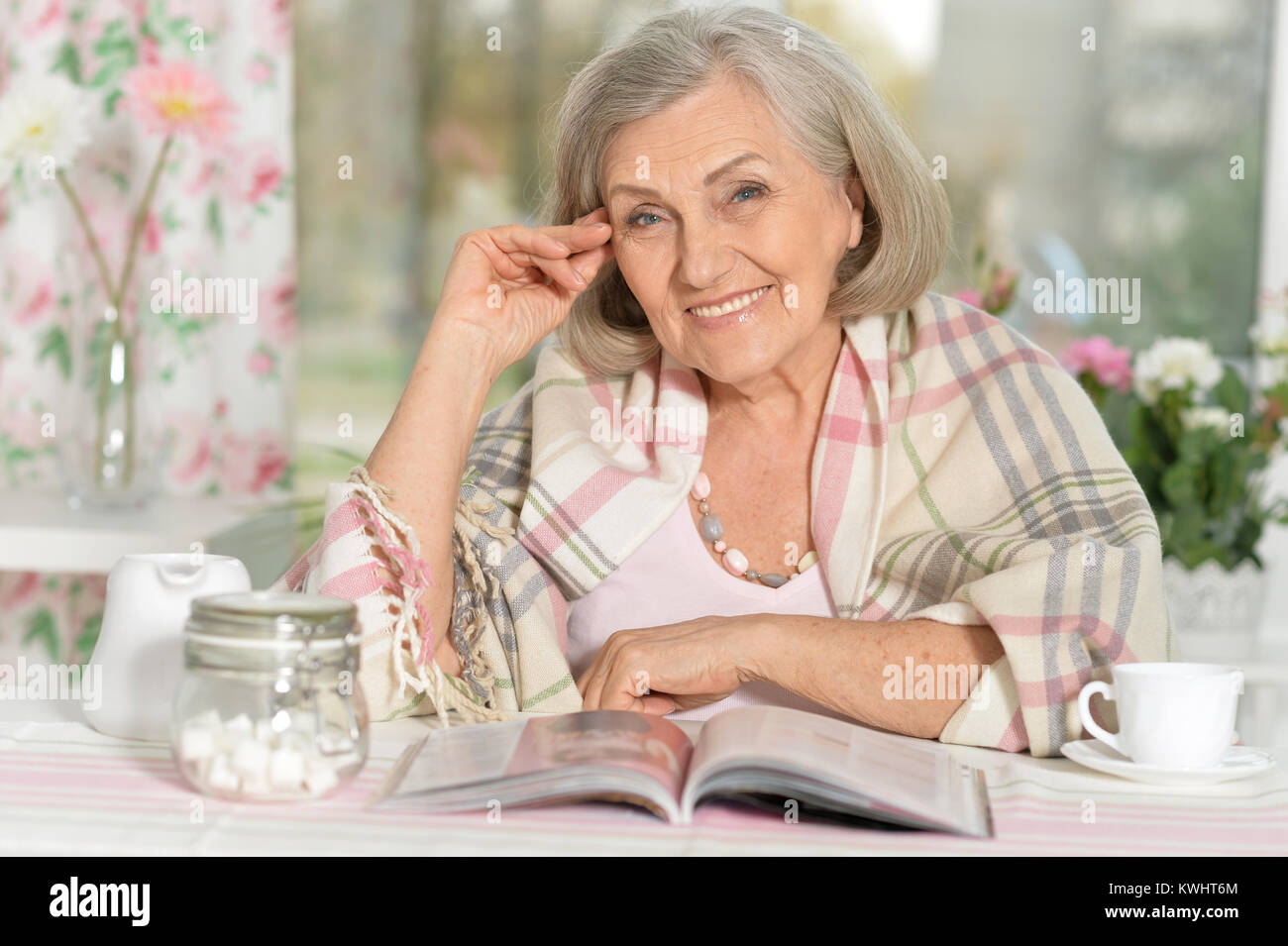 Portrait of a happy aged woman reading magazine Stock Photo - Alamy