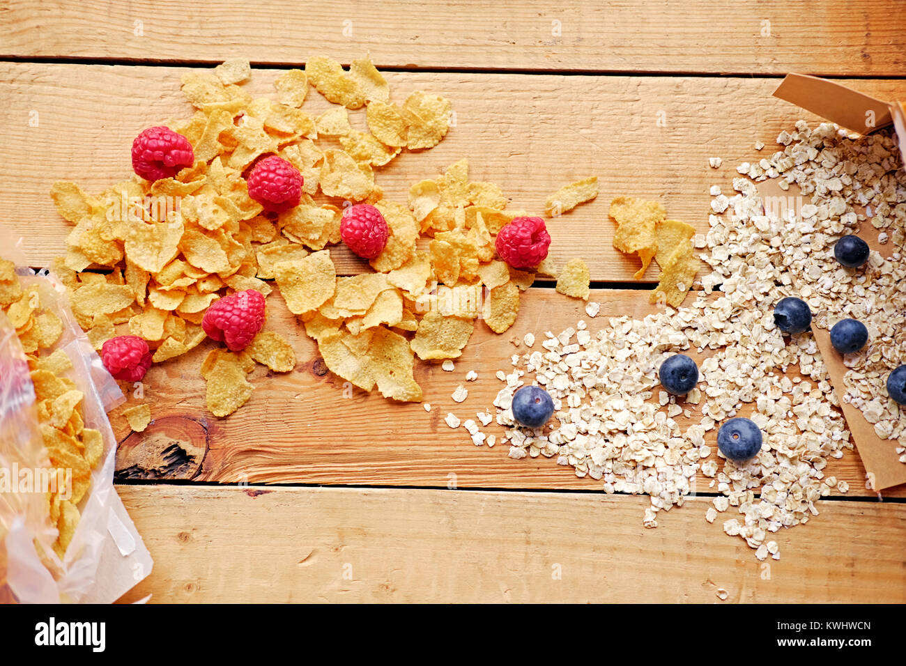 Golden corn flakes, Hercules oat and some on a wooden table Stock Photo ...