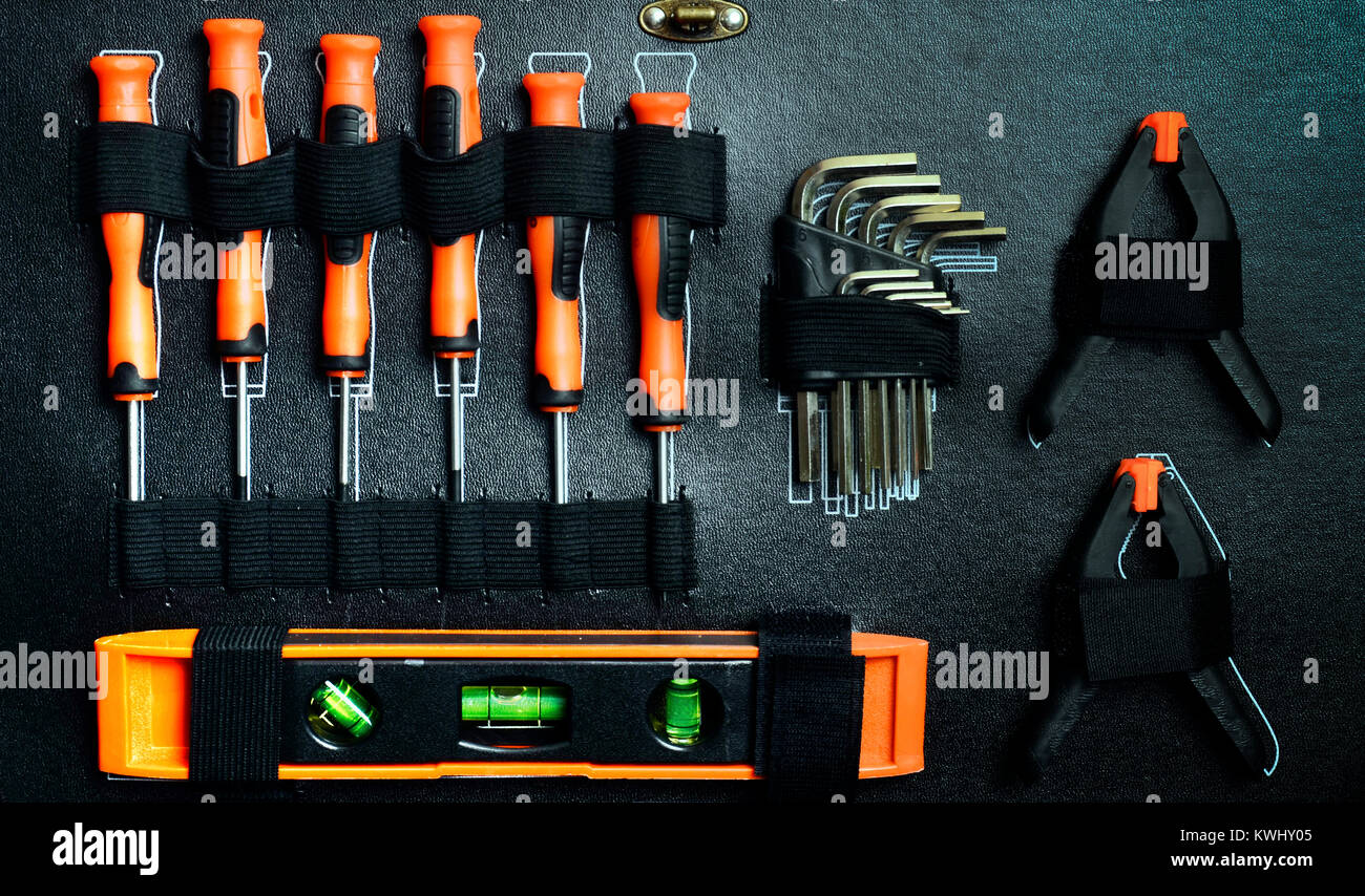 Tidy toolbox : screwdriver, levels, pliers on black background Stock ...