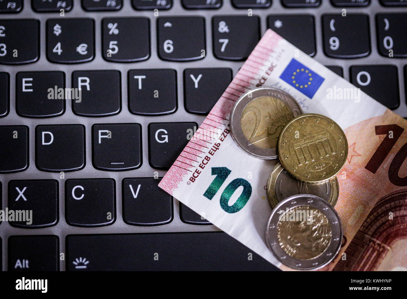 Euro coins on laptop's keyboard - make money online Stock Photo - Alamy