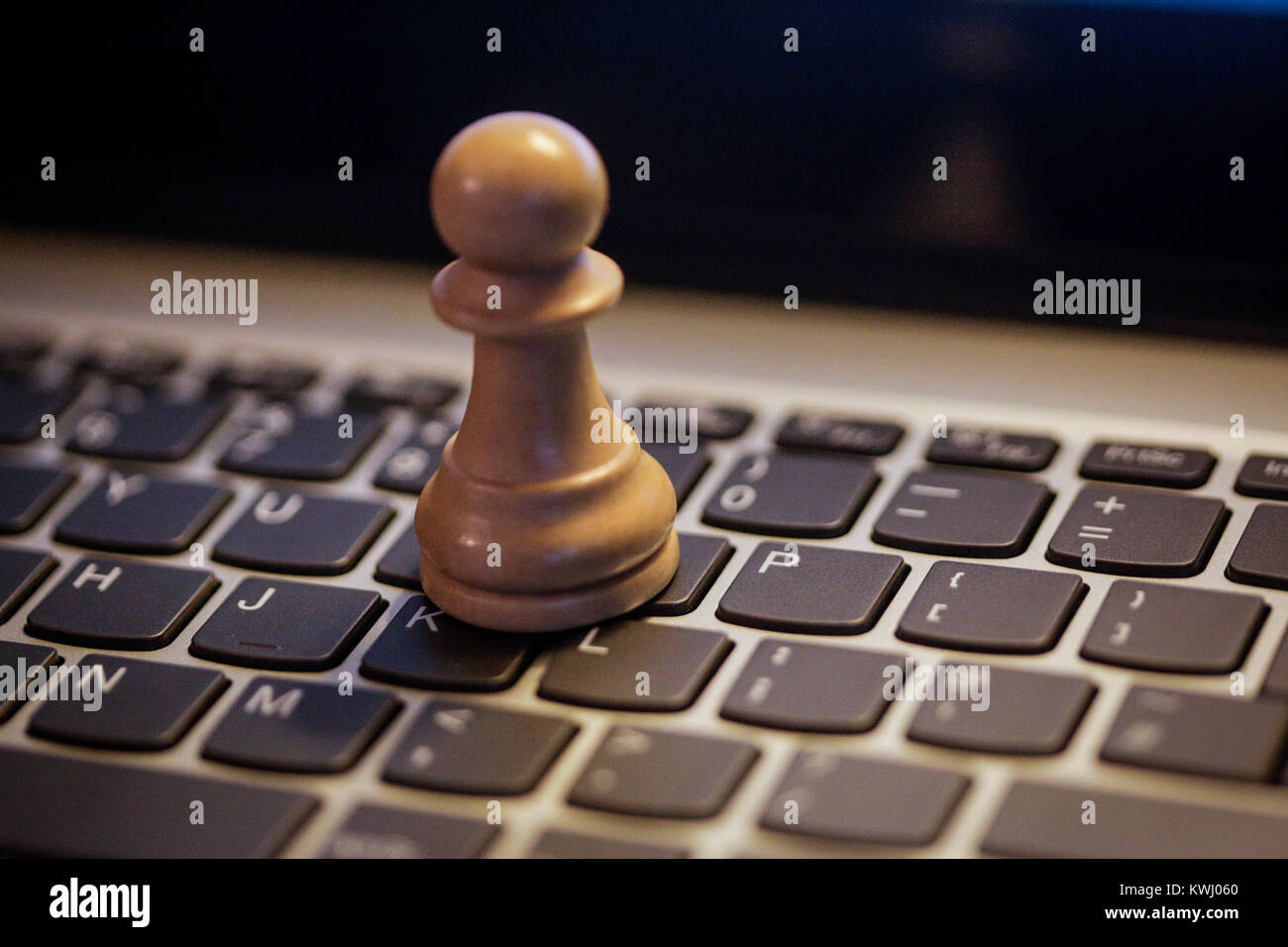 Chess pawns / kings on laptop keyboard - digital strategy Stock Photo ...